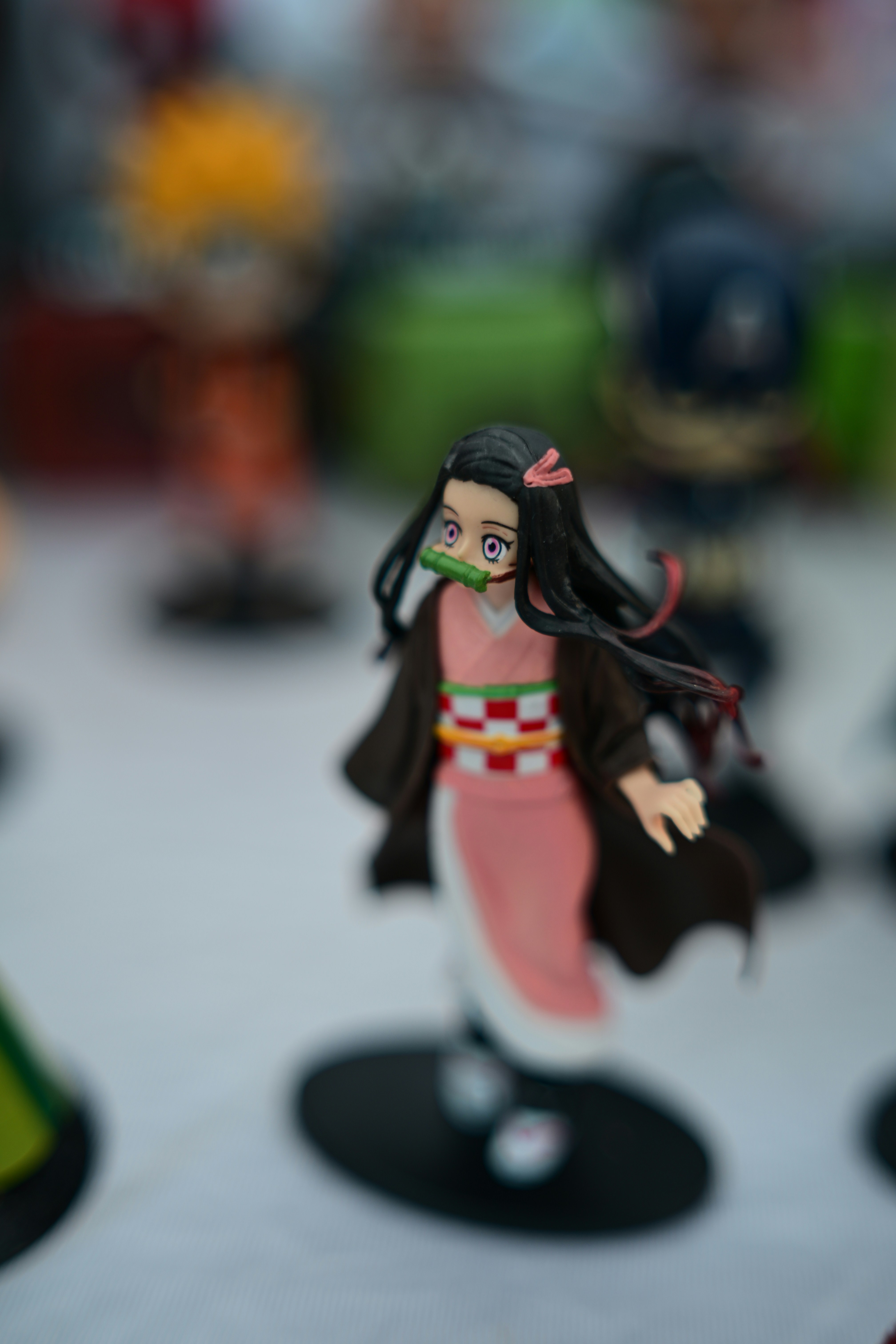 Masked Kimono Figurine Standing in Focus Amid Blurred Background