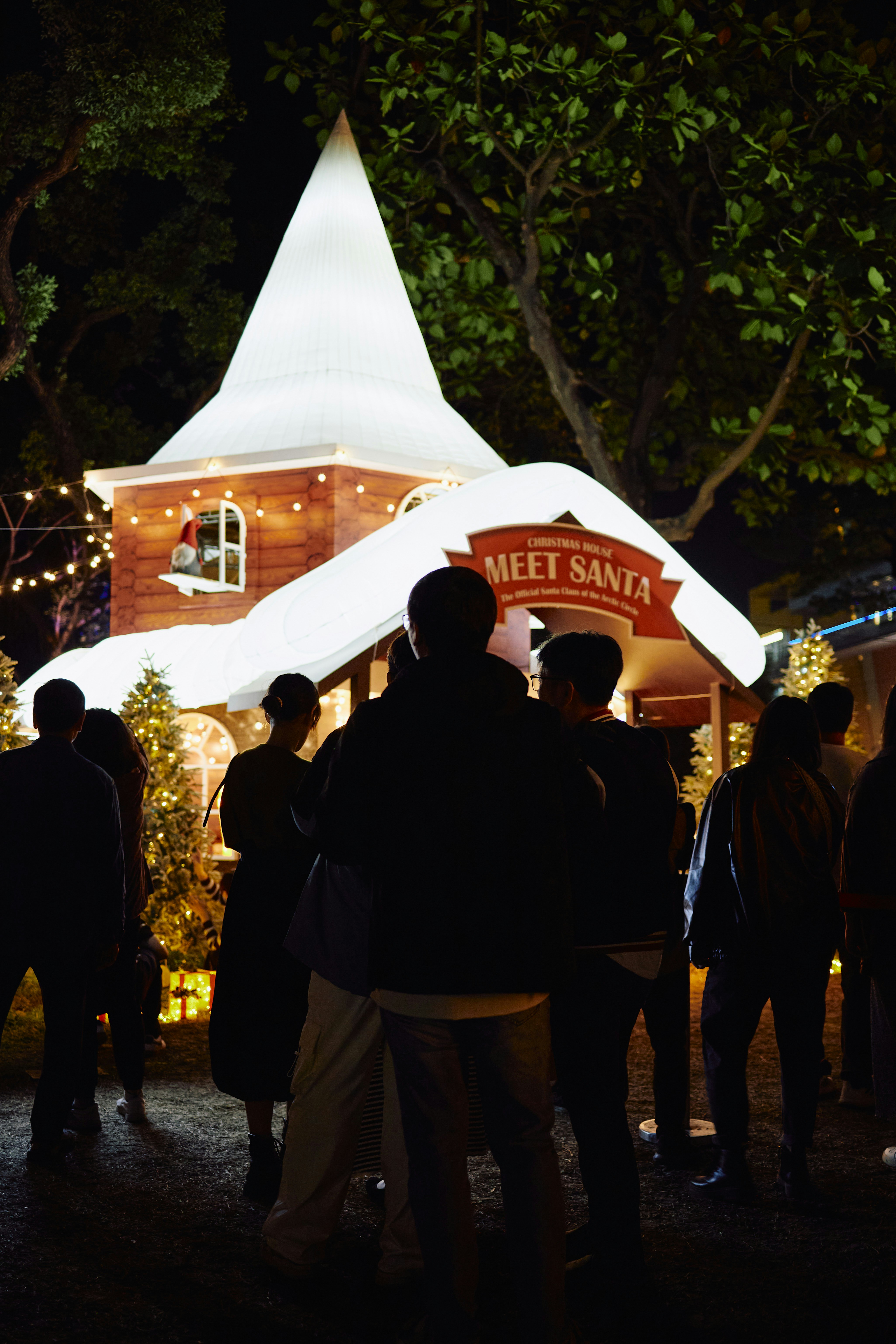 Meet Santa at the Night Market: Warm Glow Behind the Silhouettes