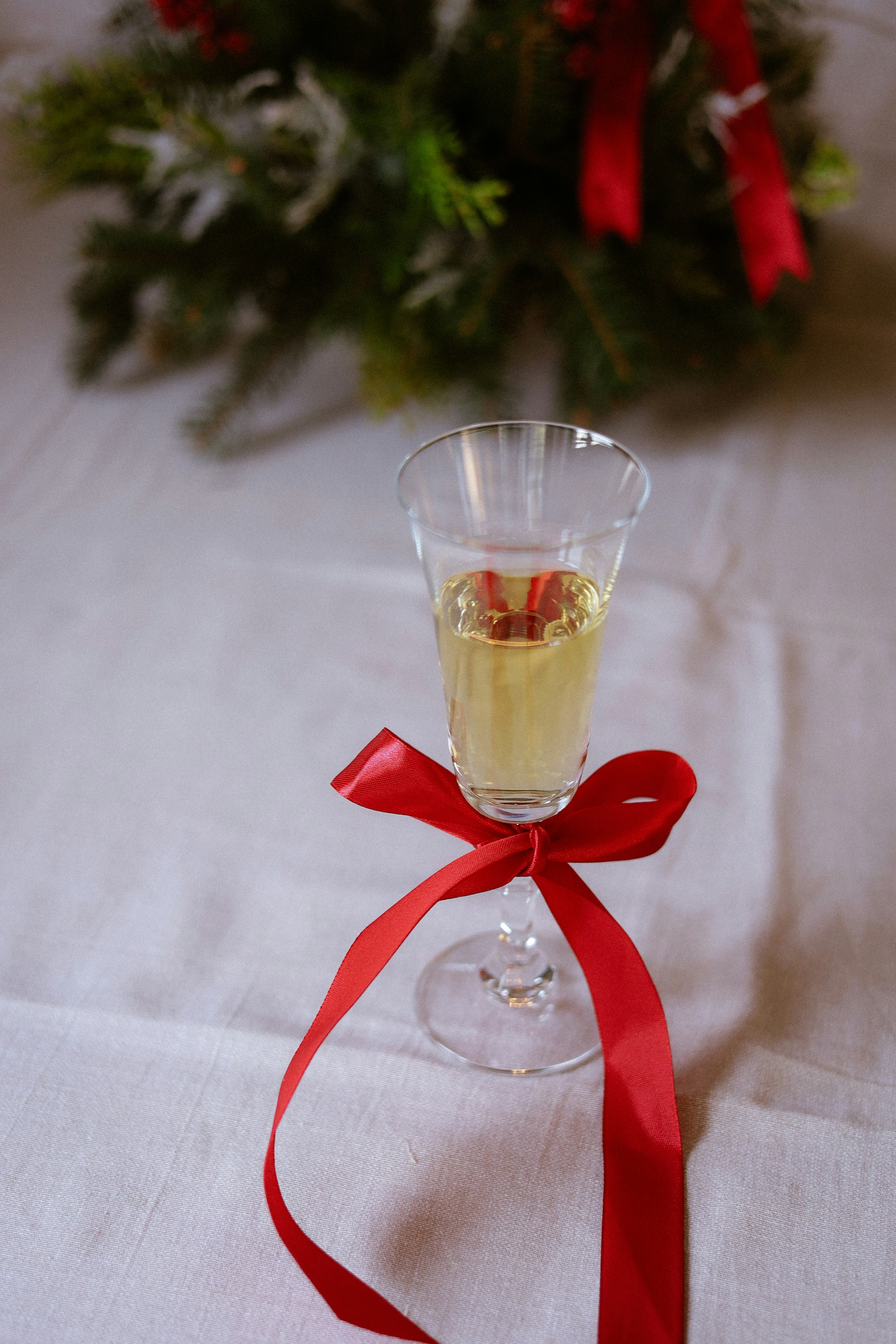 Champagne Glimmer: A Christmas Toast with Red Ribbon Accent