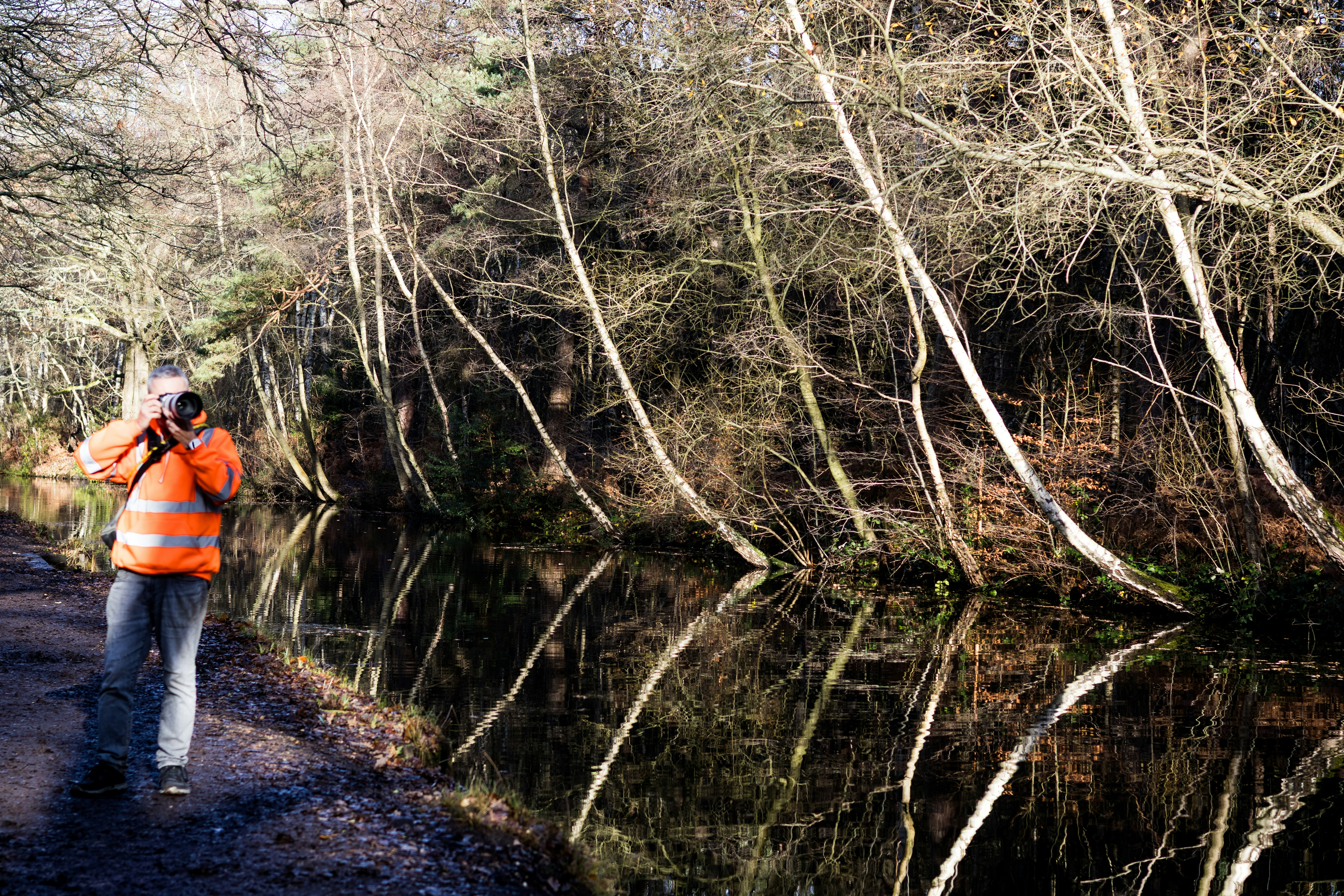 Orange Vest, Quiet Stream: a photographer in the woods