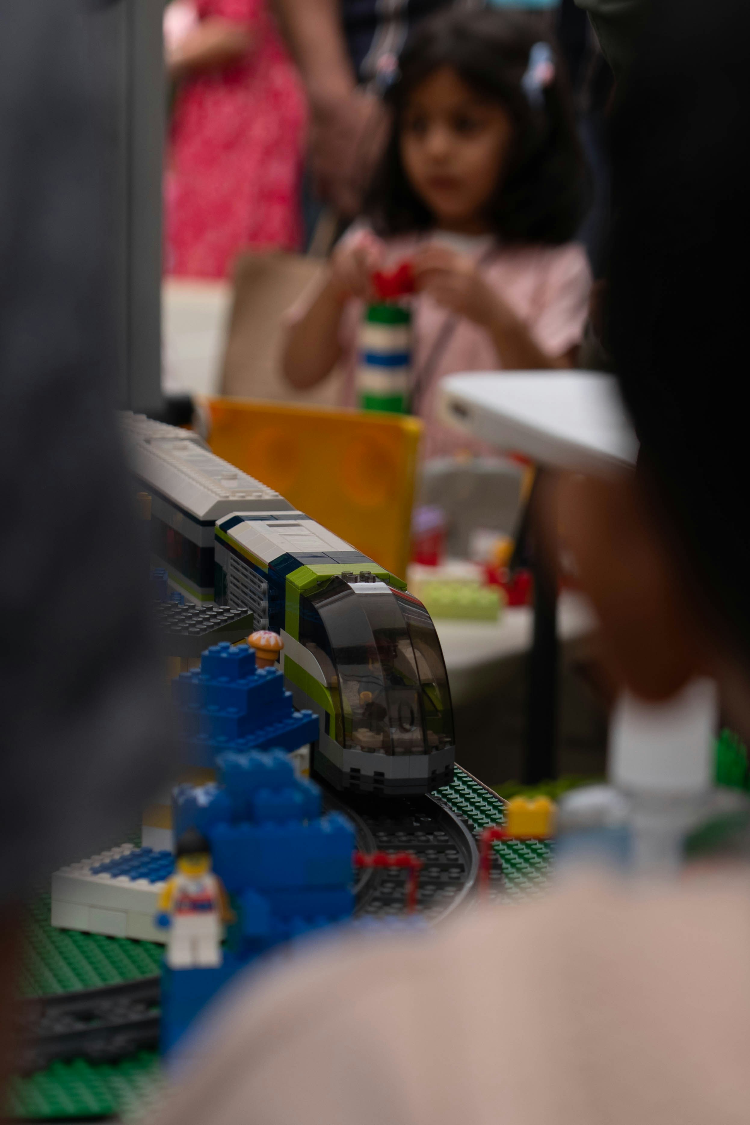 Tunnel of LEGO: A Moving Train Scene Among Hungry Onlookers