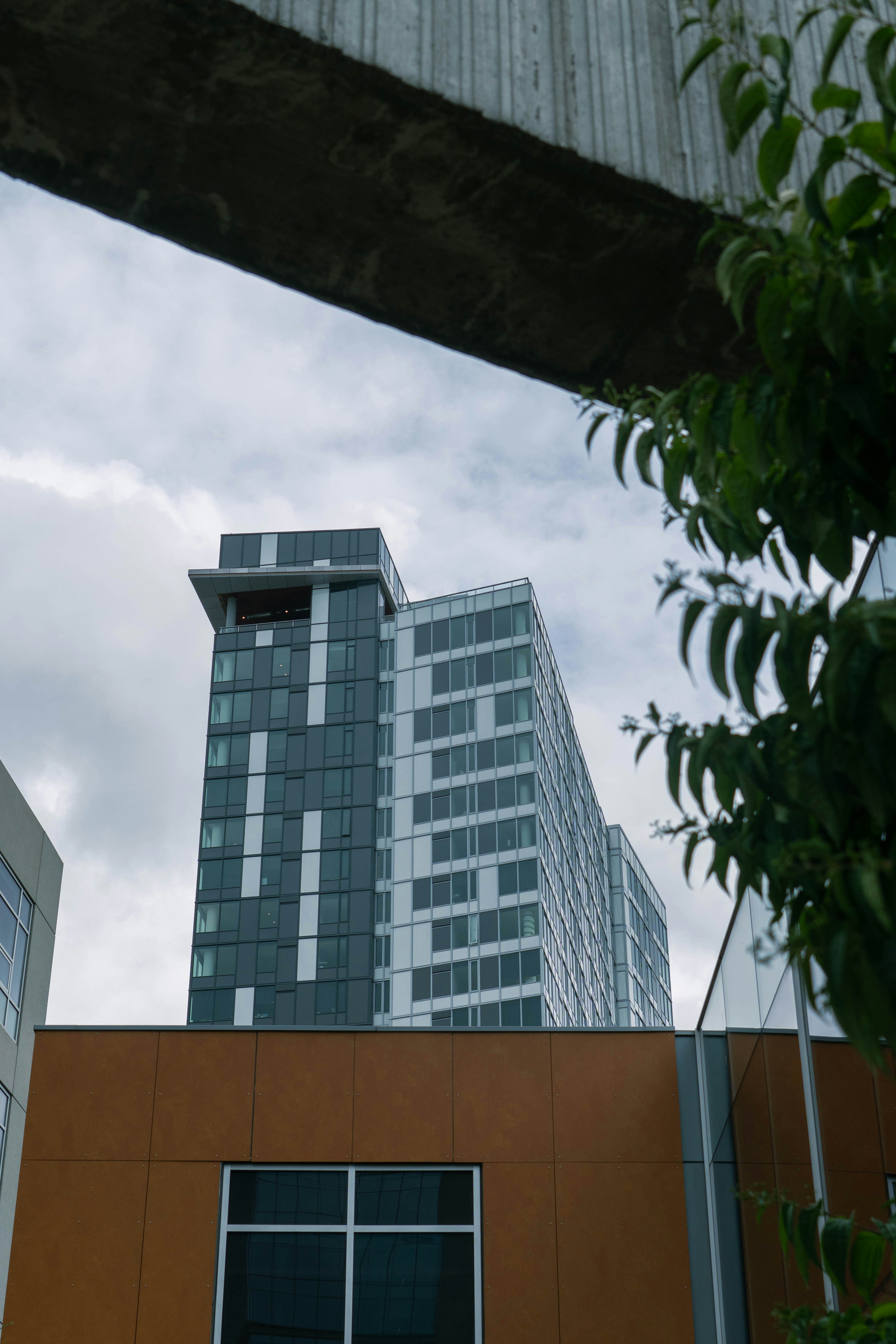 Urban Prism: Glass Towers Rising Under a Framing Canopy