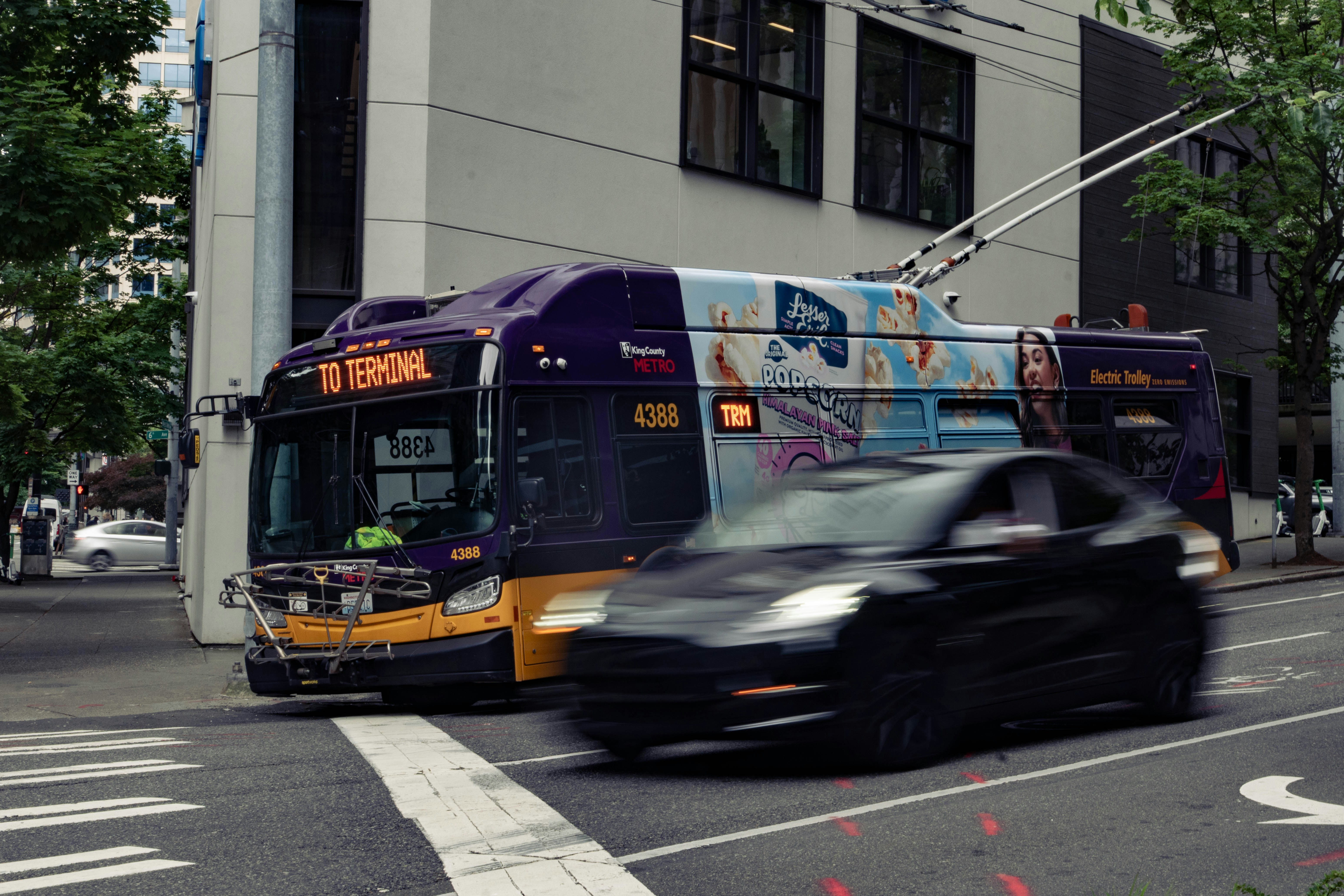 Bus Clash at the Intersection: A Blurred Car in Motion