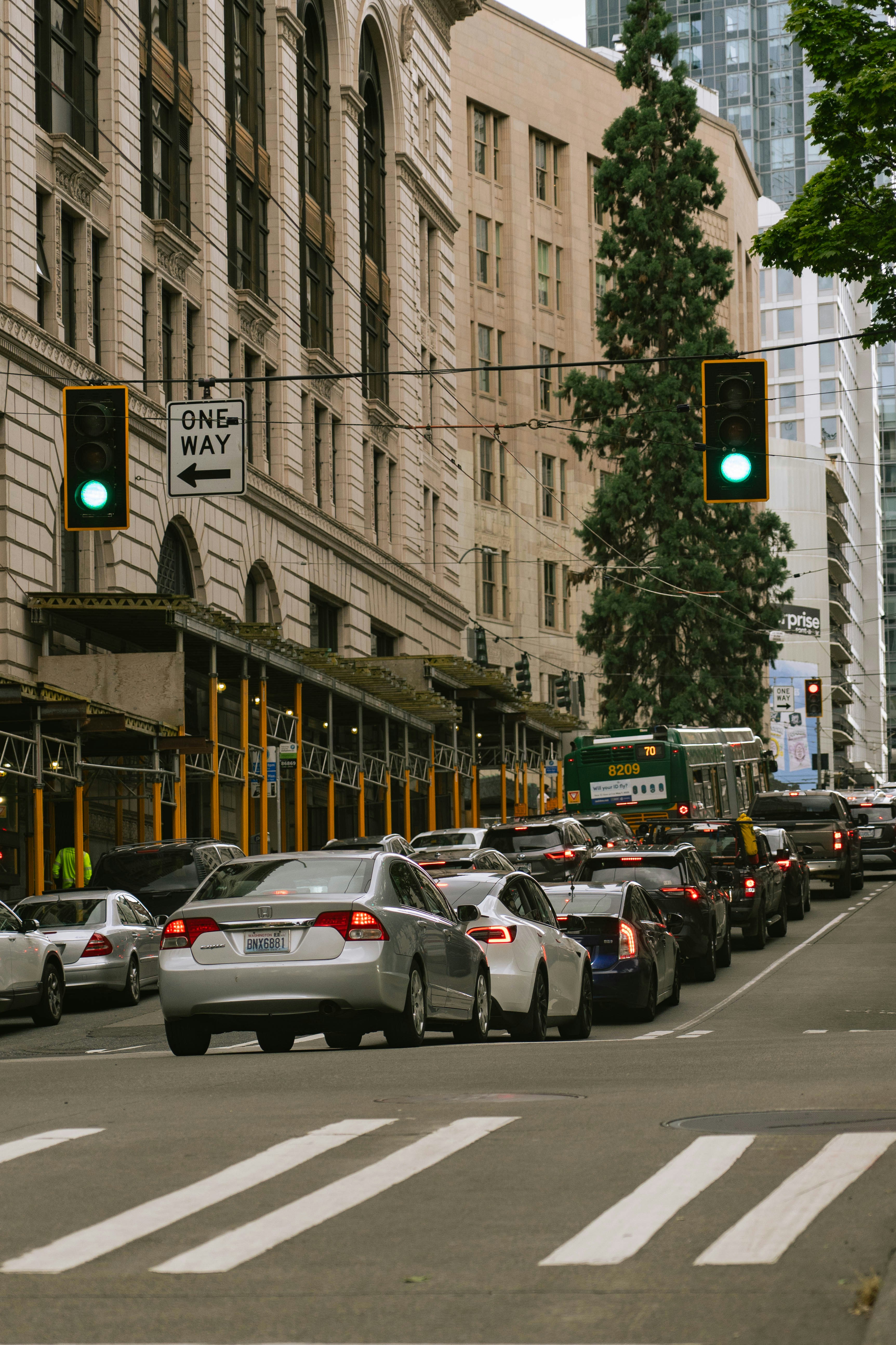 Rush Hour Confluence: A City Street Framed by Historic Facades