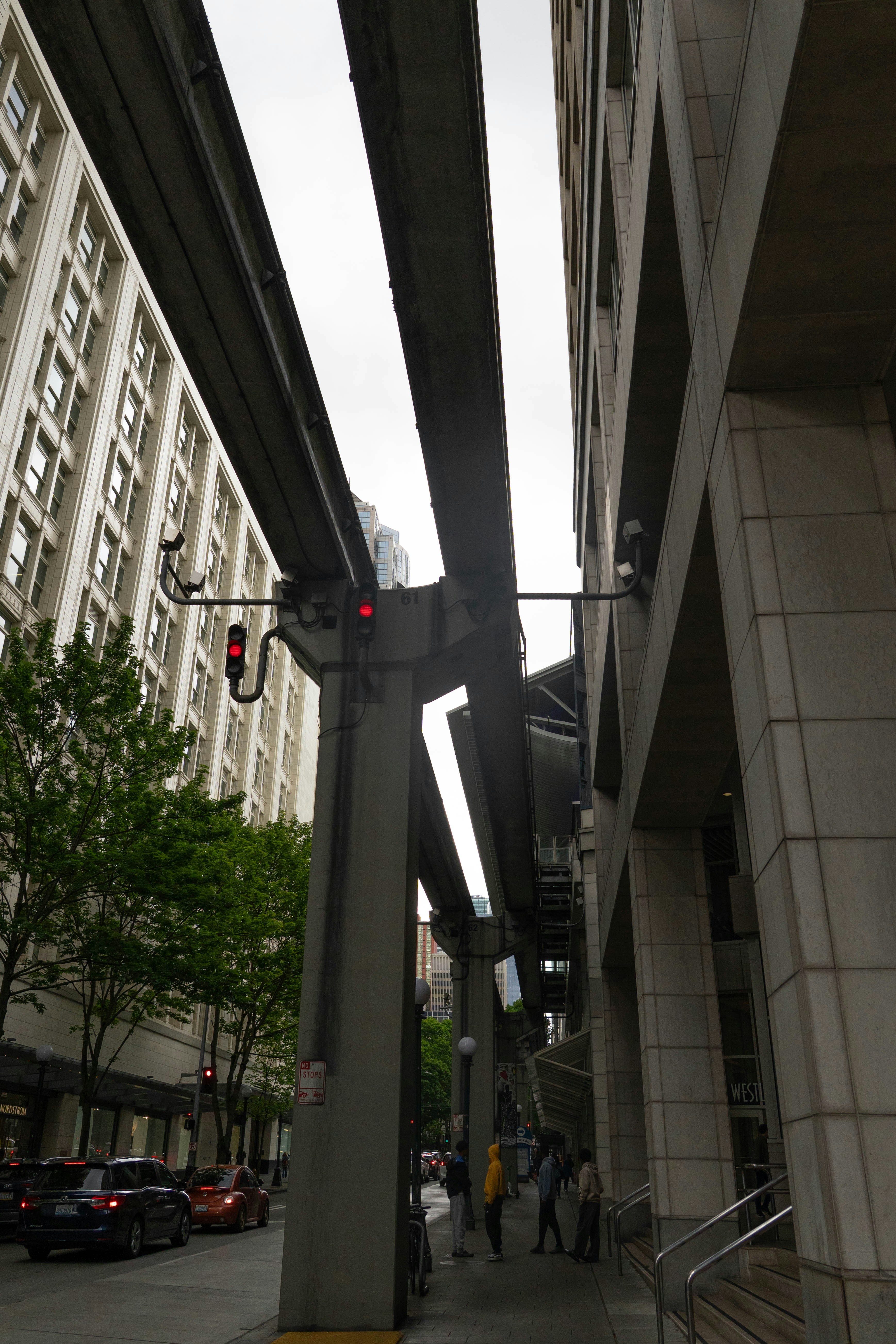 Monorail tracks pass between modern city buildings. photo – Free Cars ...