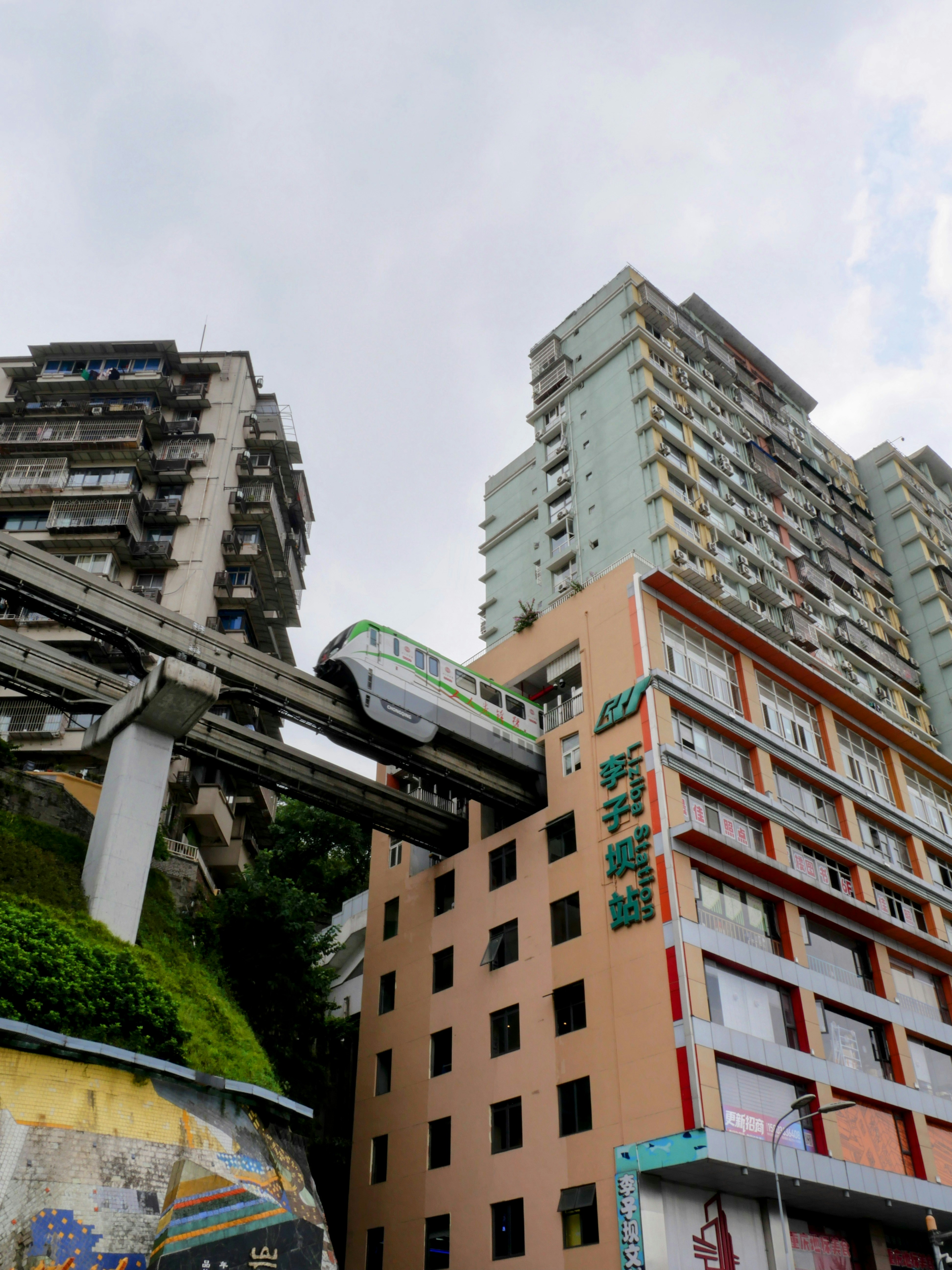 Monorail train passing through apartment buildings photo – Free ...