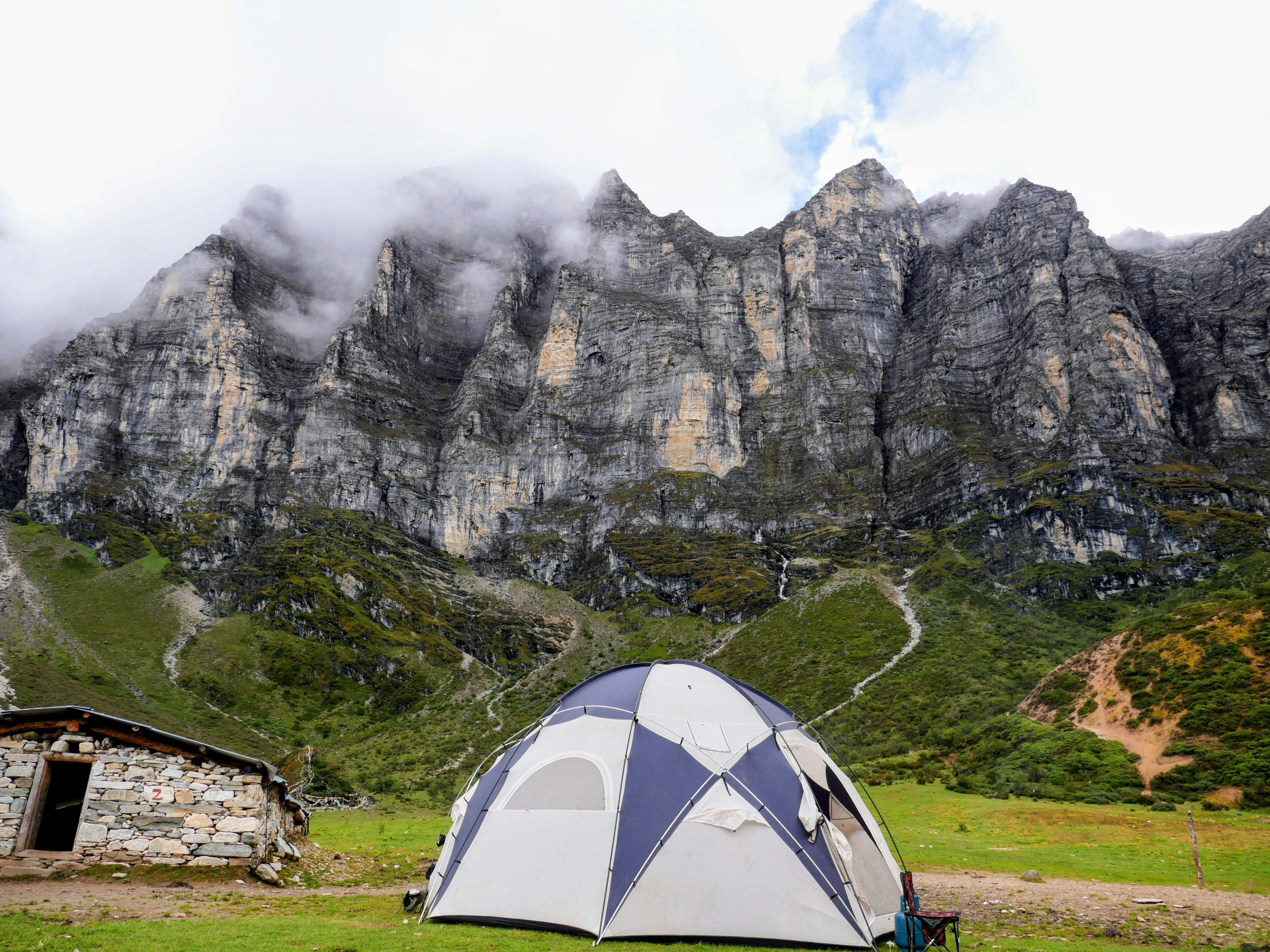 Mountainous Backdrop and Camped Dome: A Quiet Valley at Dusk