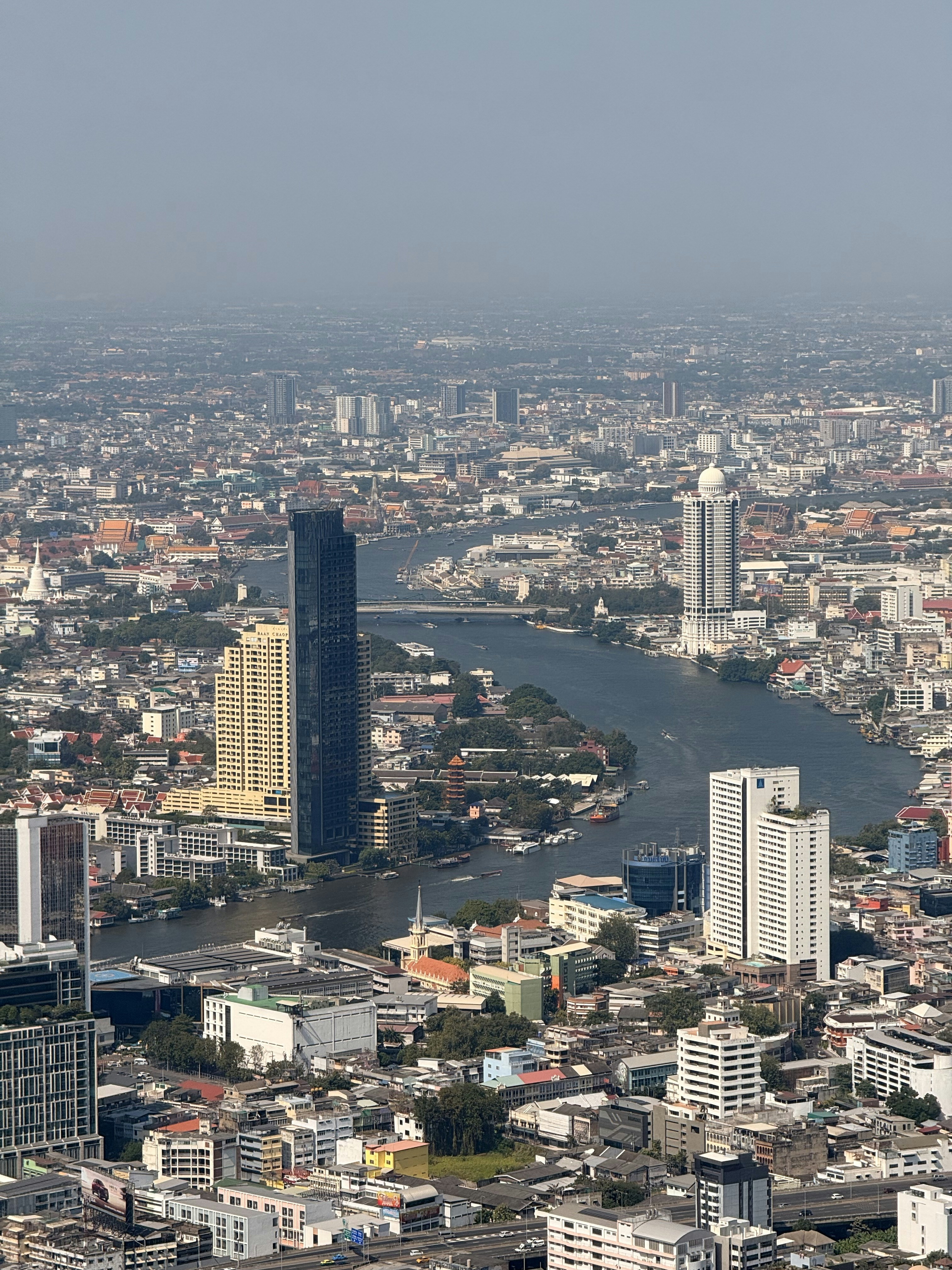 Riverbend Skyline: Towers Rising Over the Urban Veil