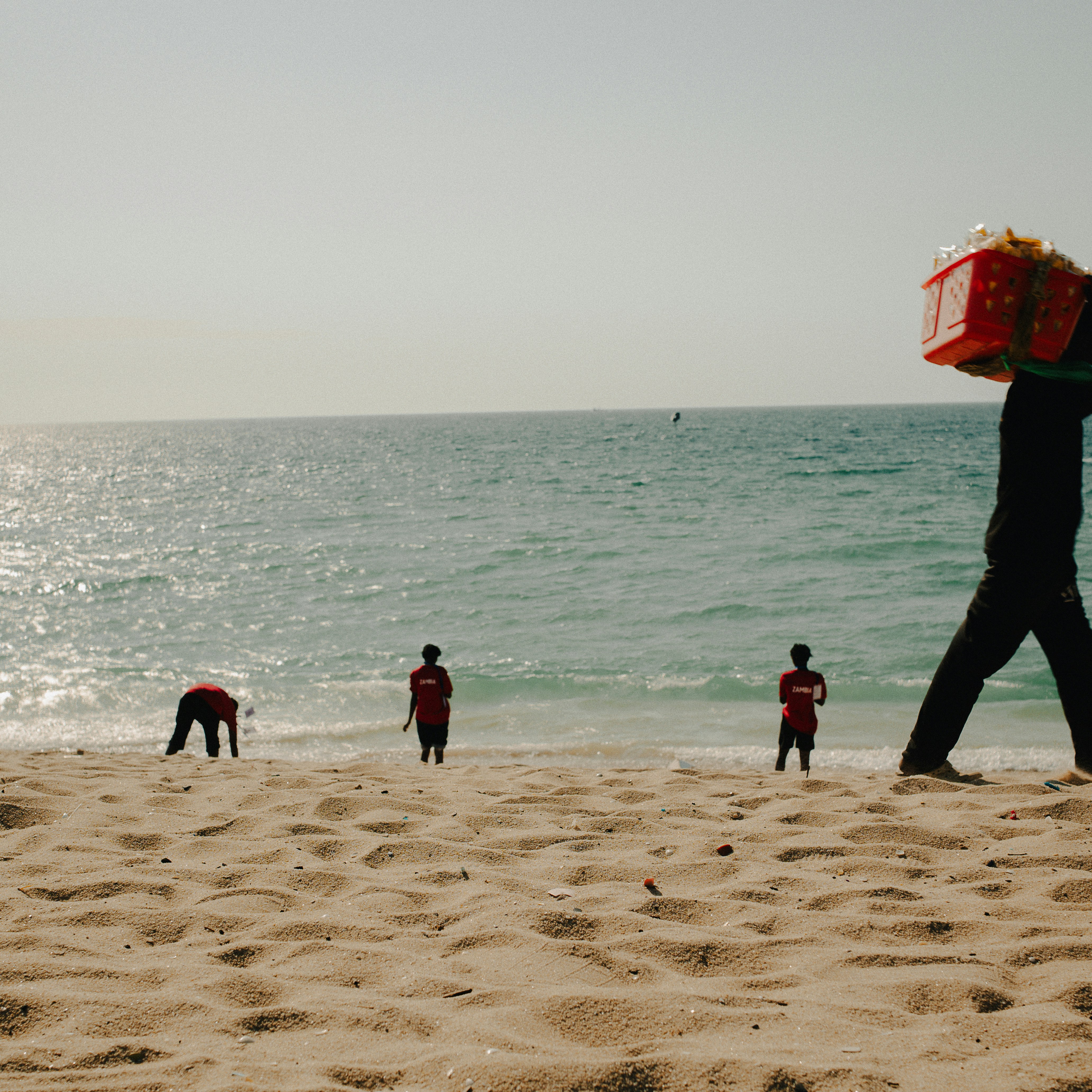 Gift in Hand, Wave at Dusk: Beach Scene with Seaside Silhouettes