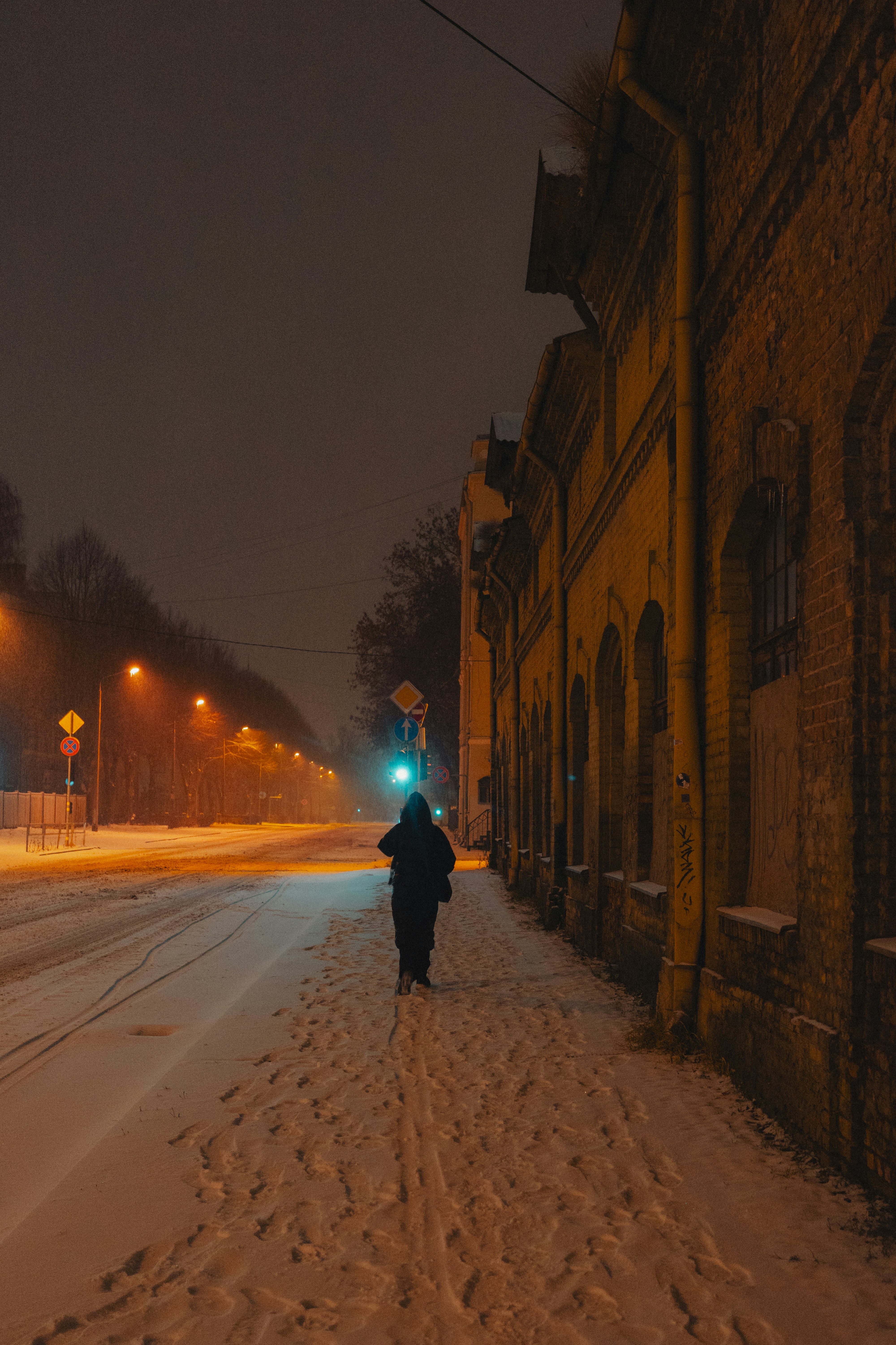 Midnight Stroll Along a Snowy Industrial Street