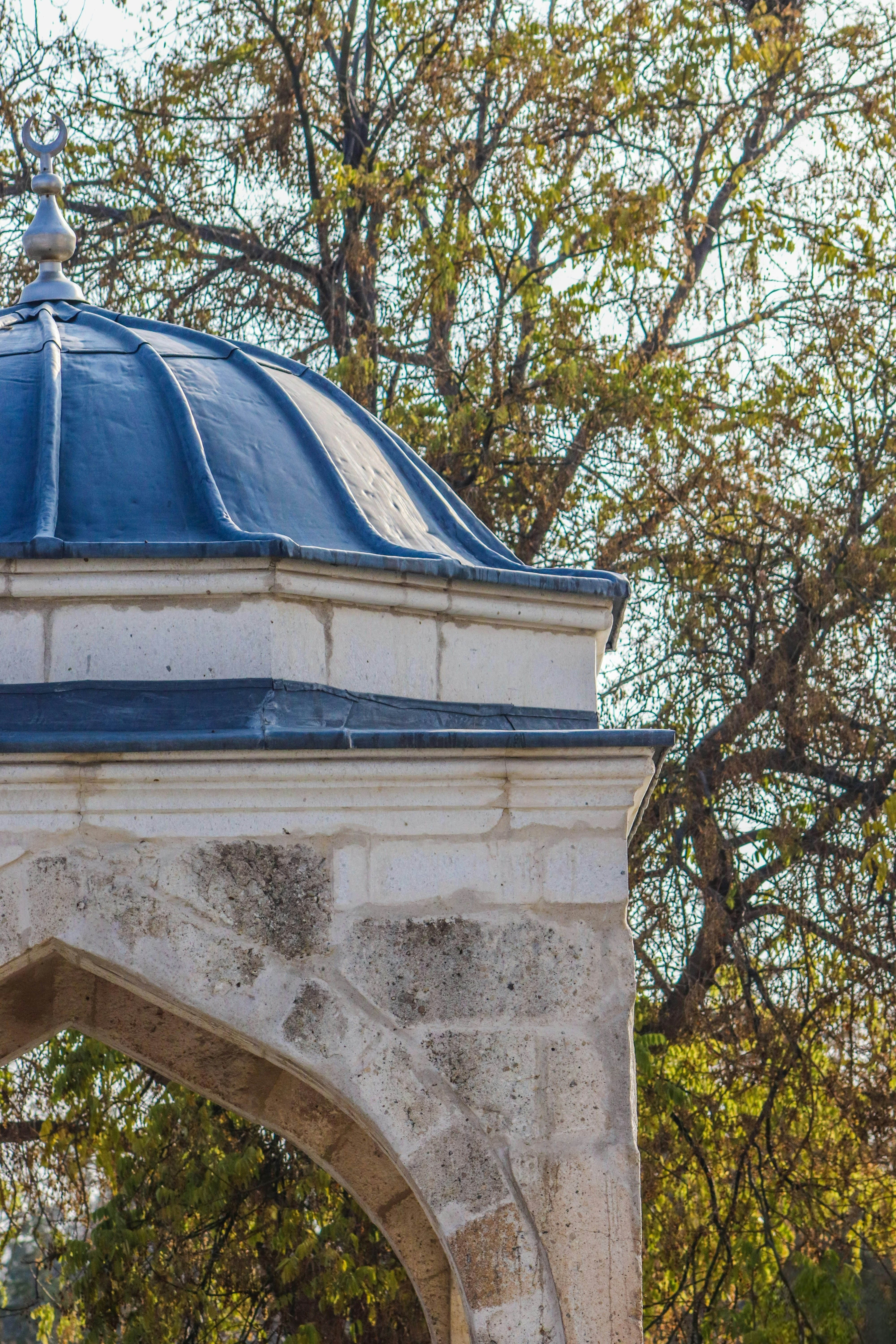 Blue Dome Over Stone Archway in Sunlit Park
