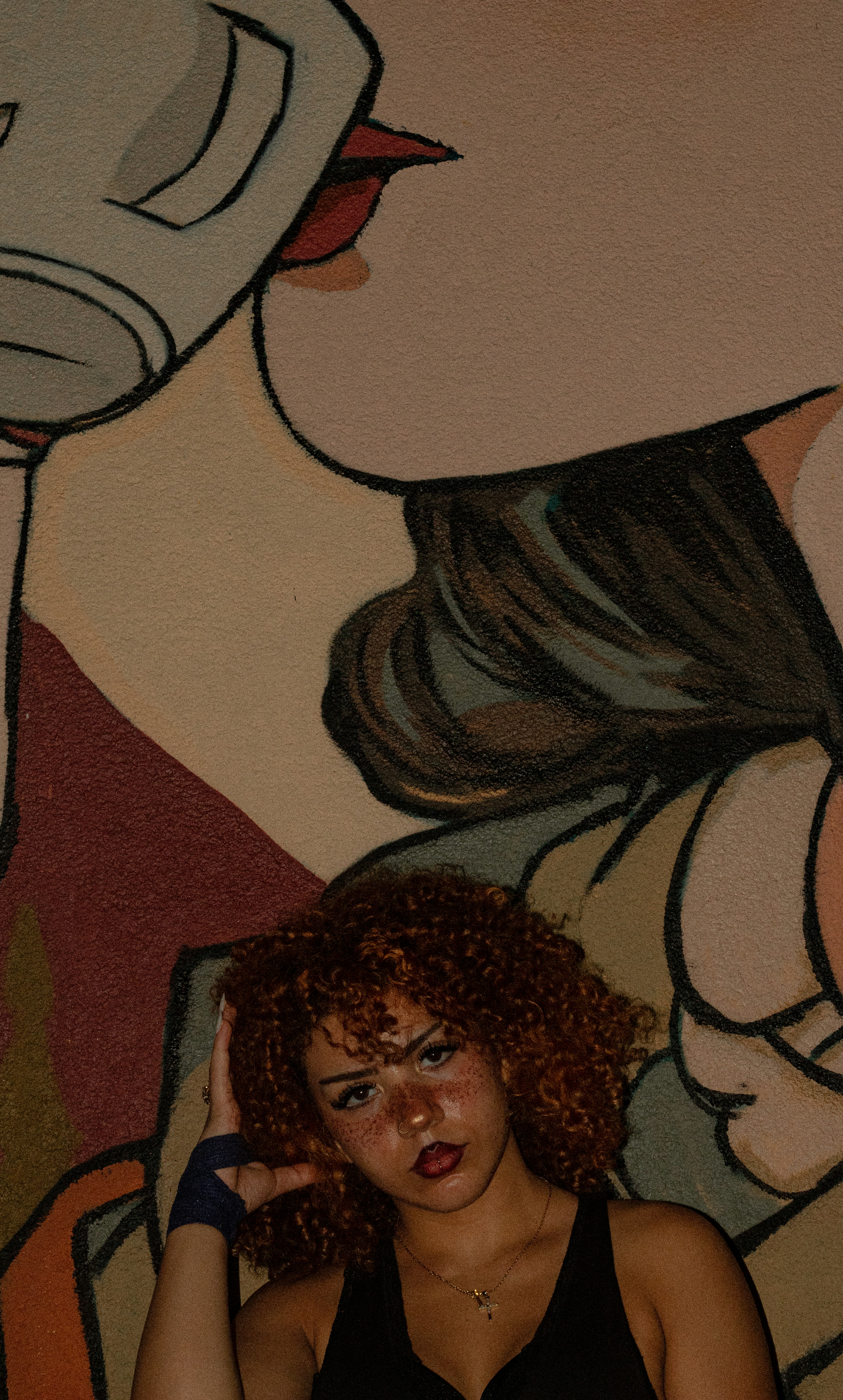 Curled Confidence under a Mural Face