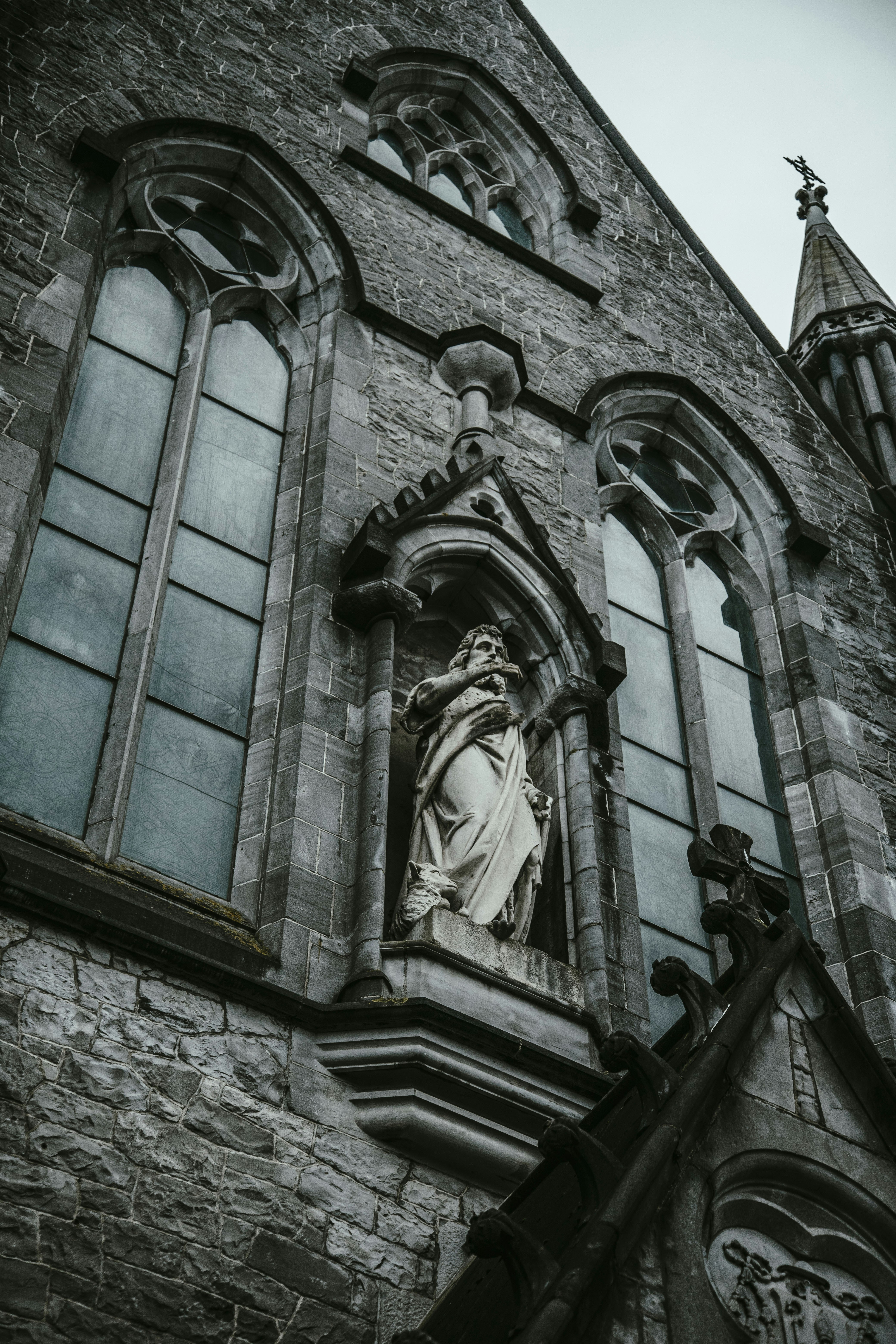 Gothic Facade: A Saint Watches Over the Weathered Stones