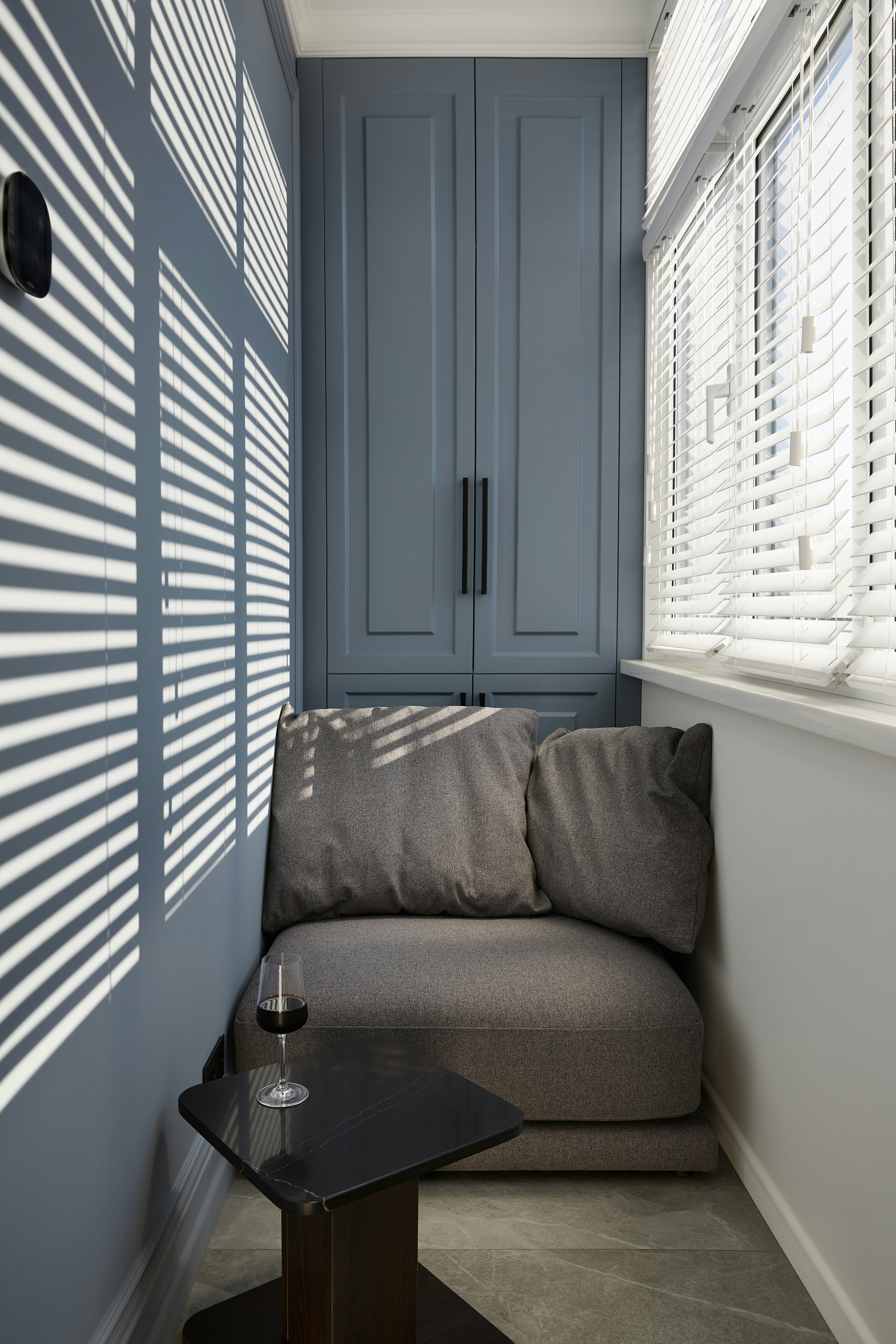 Shadowed Slats and Soft Seating: A Sunlit Corner