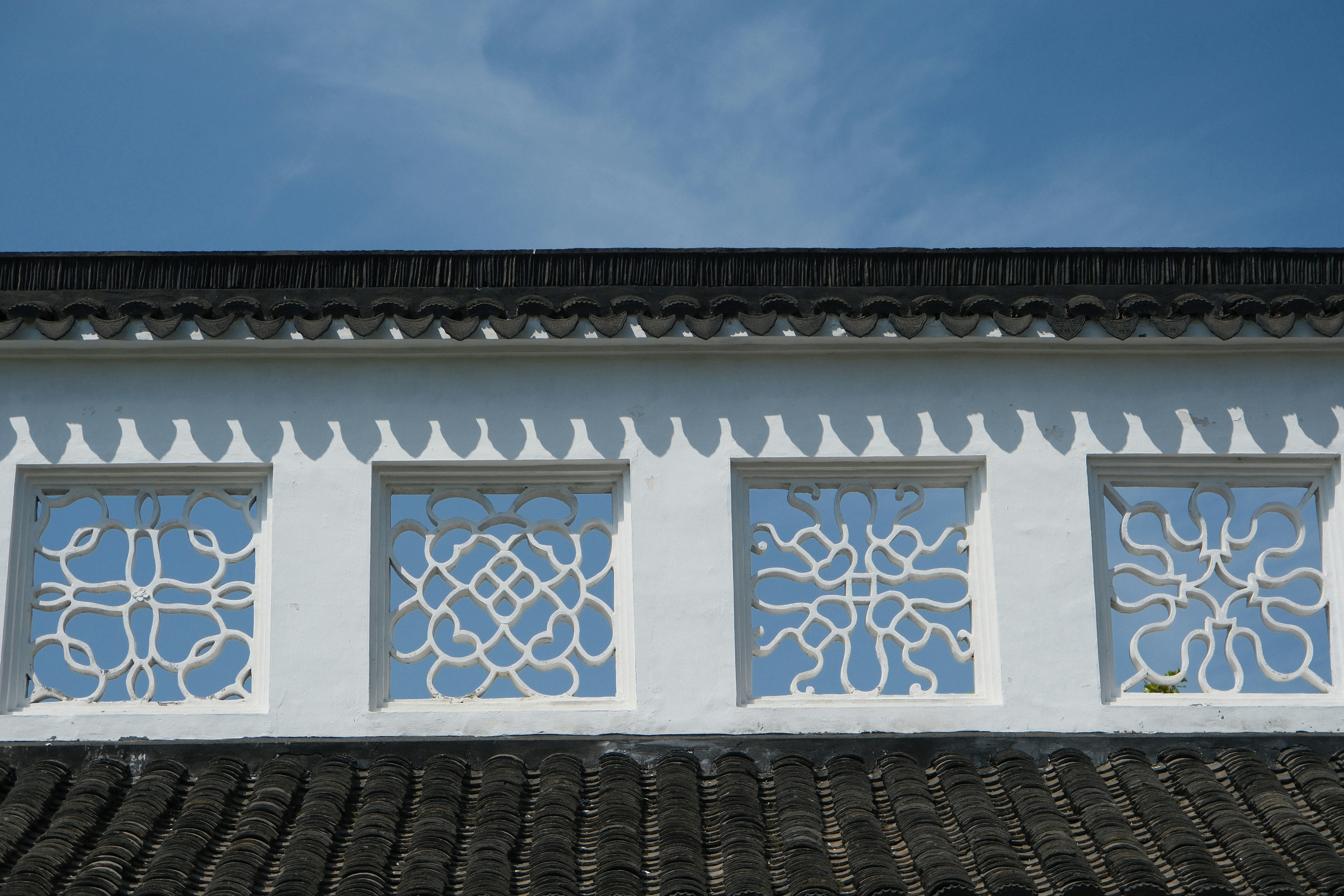 White Framed Lattice Windows under a Tile RoofCarbyn Wu