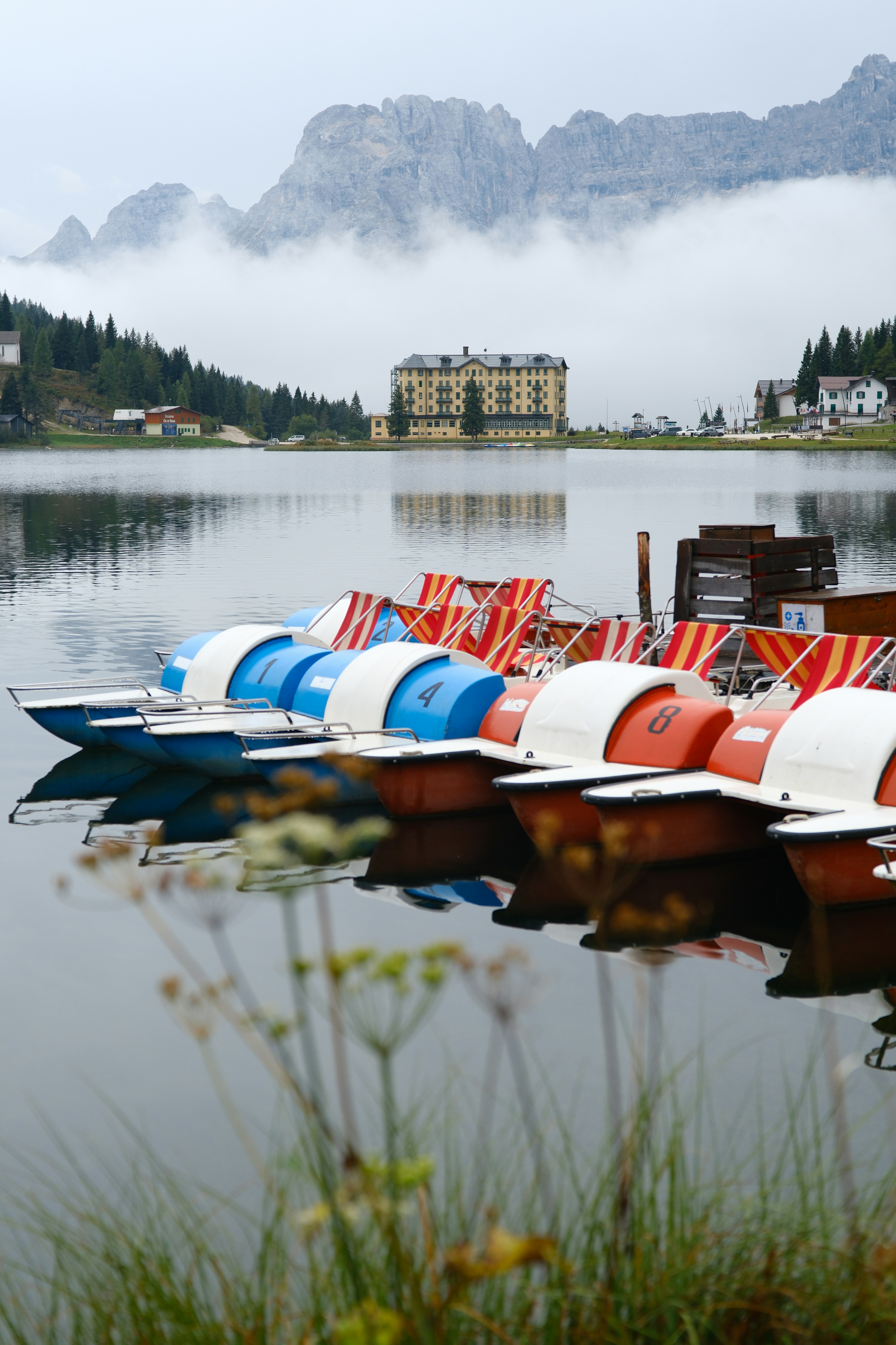 Rowing Boats at the Quiet Lakeside Under Misty Alpine Peaks