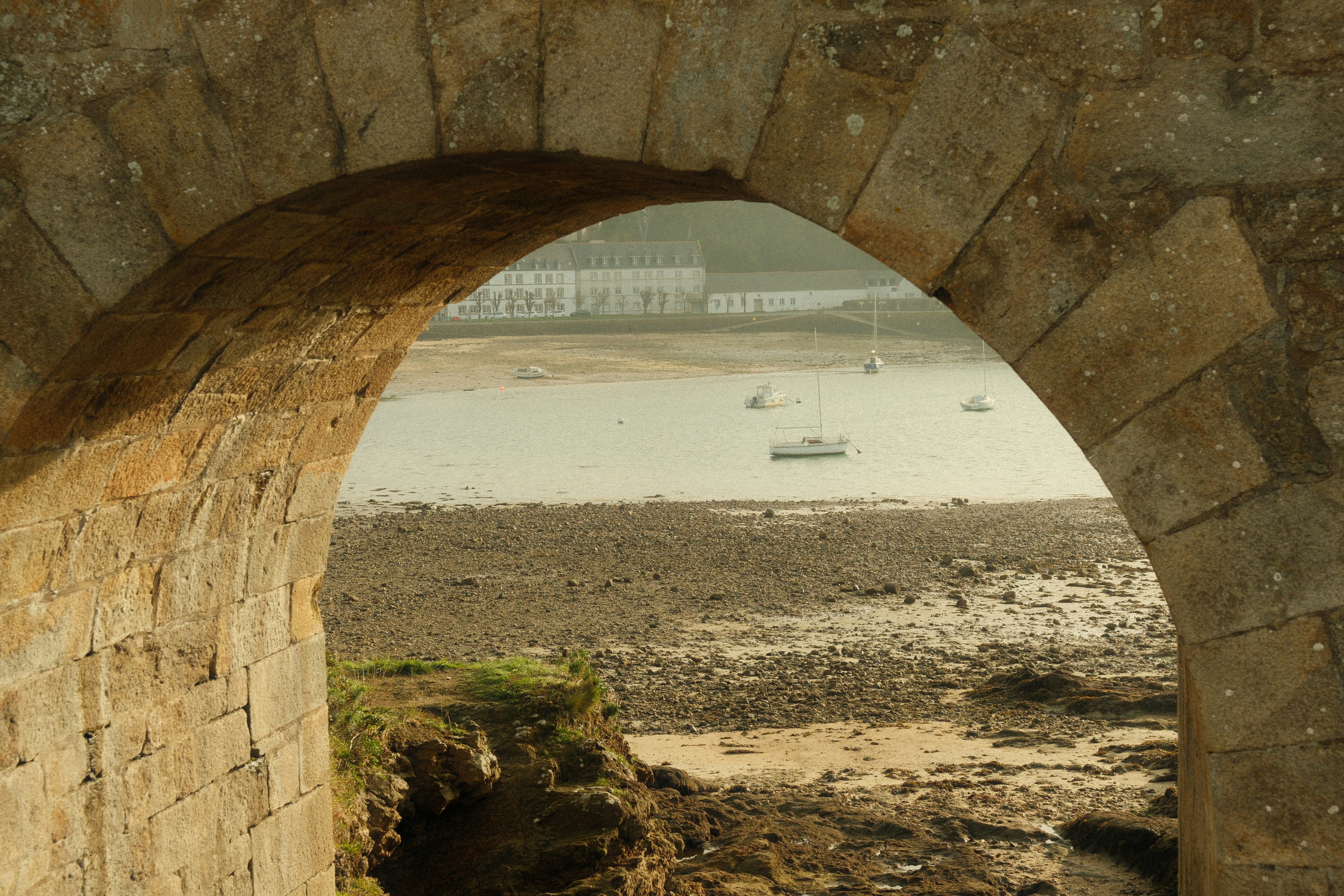 Archway to the Tidal Quiet: Boats Beyond the Stone Curve