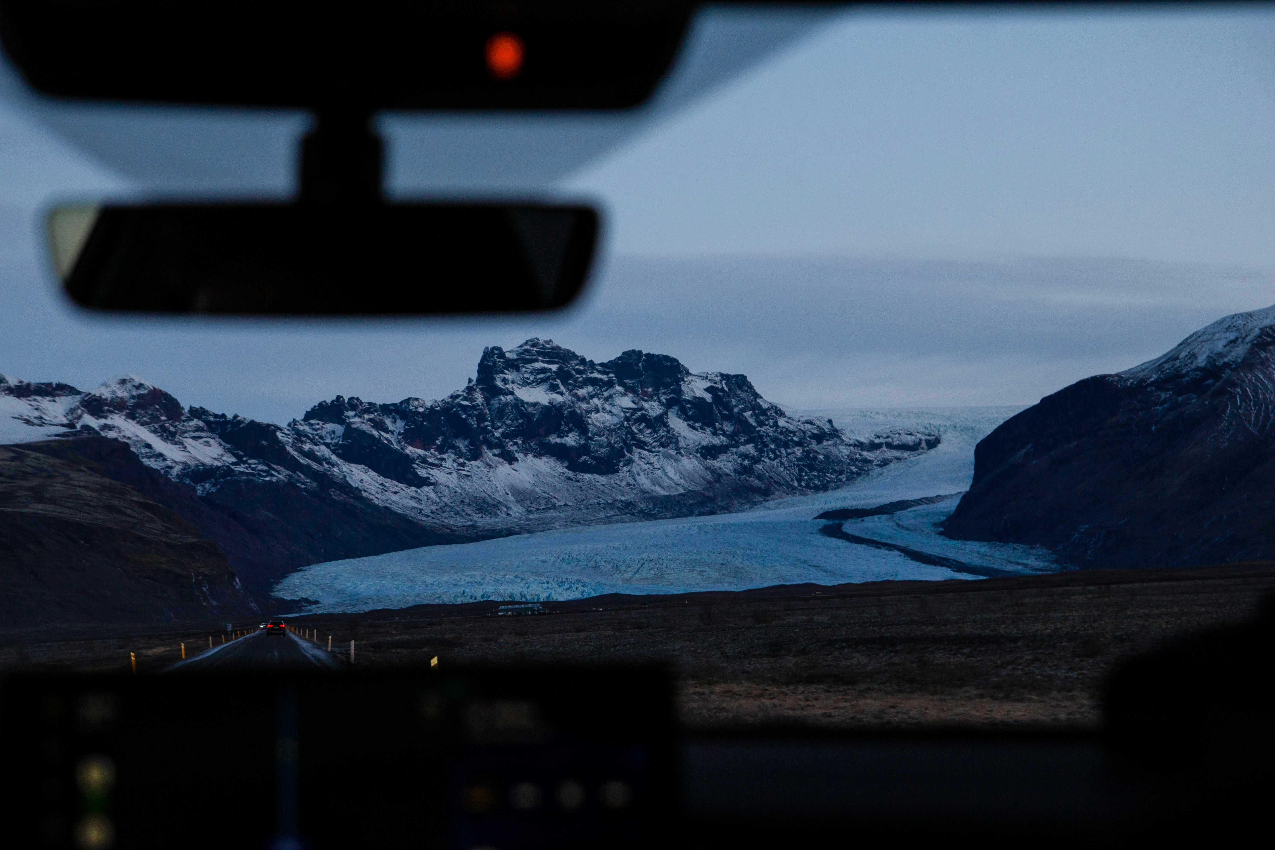 Glacial Road: Snow-Trimmed Fjord Through the Windshield