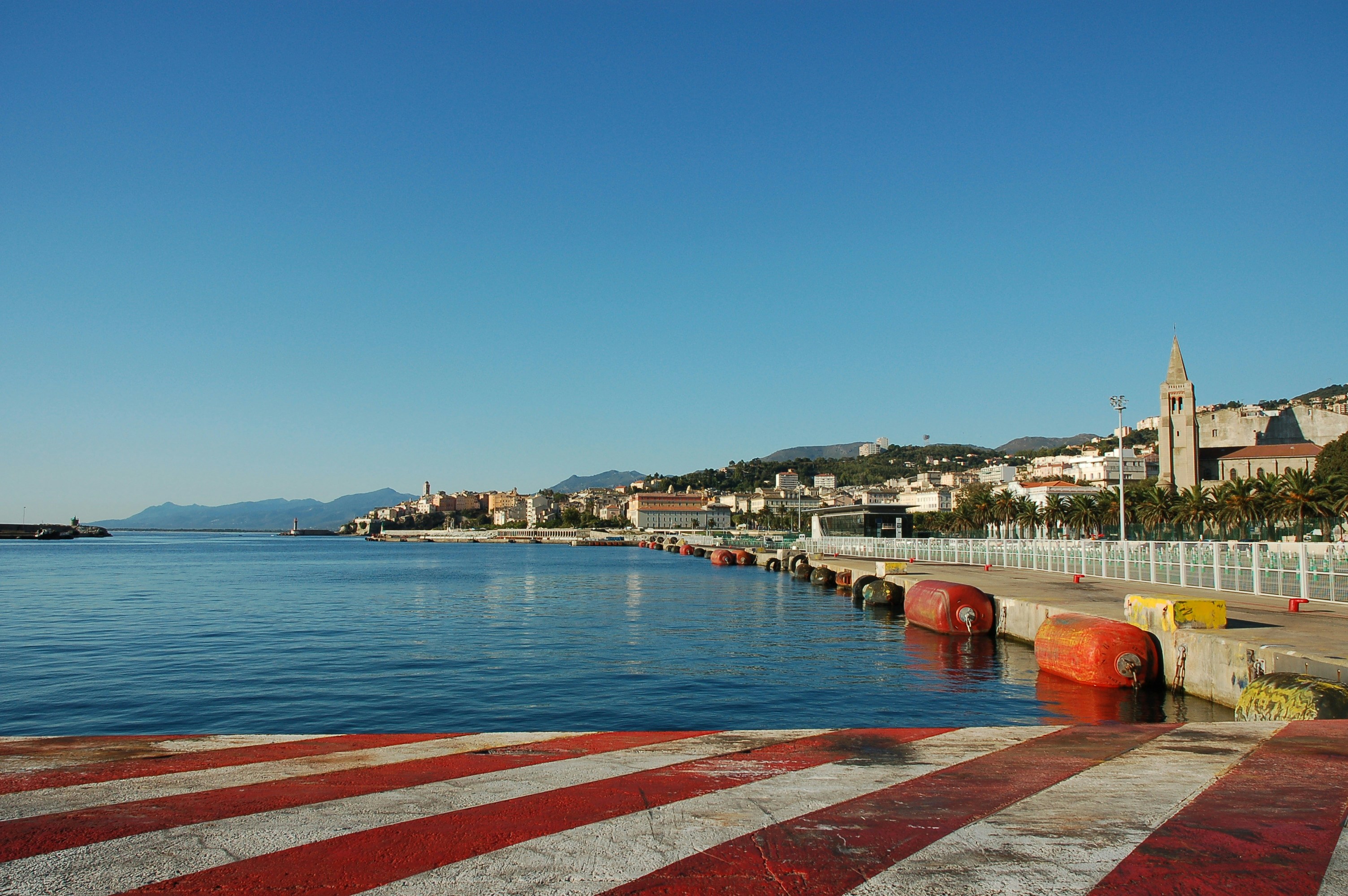 Harbor Boulevard: Red-and-White Striped Concrete Meet the Calm Seascape