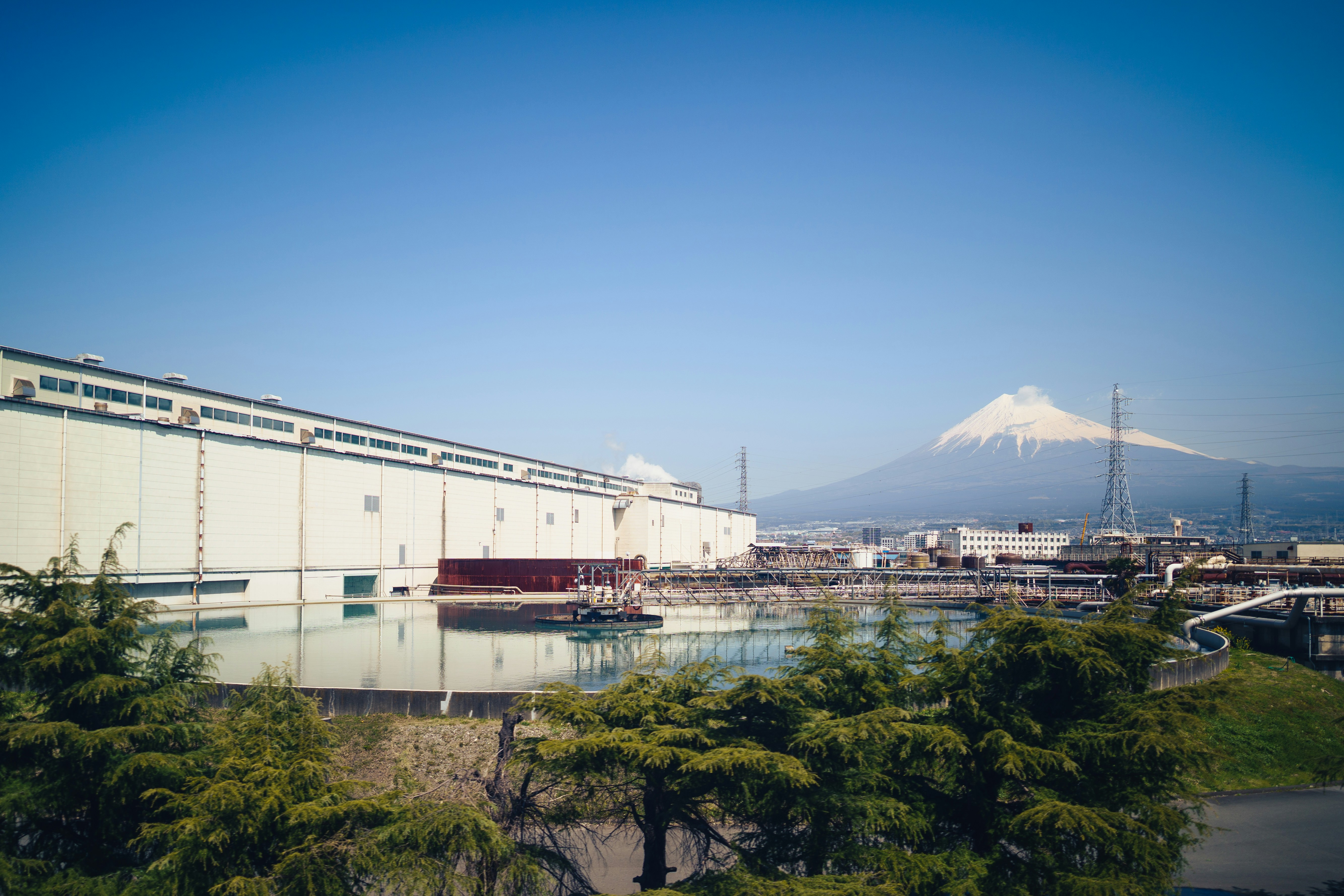 Mount fuji behind industrial buildings and trees photo – Free Blue sky ...