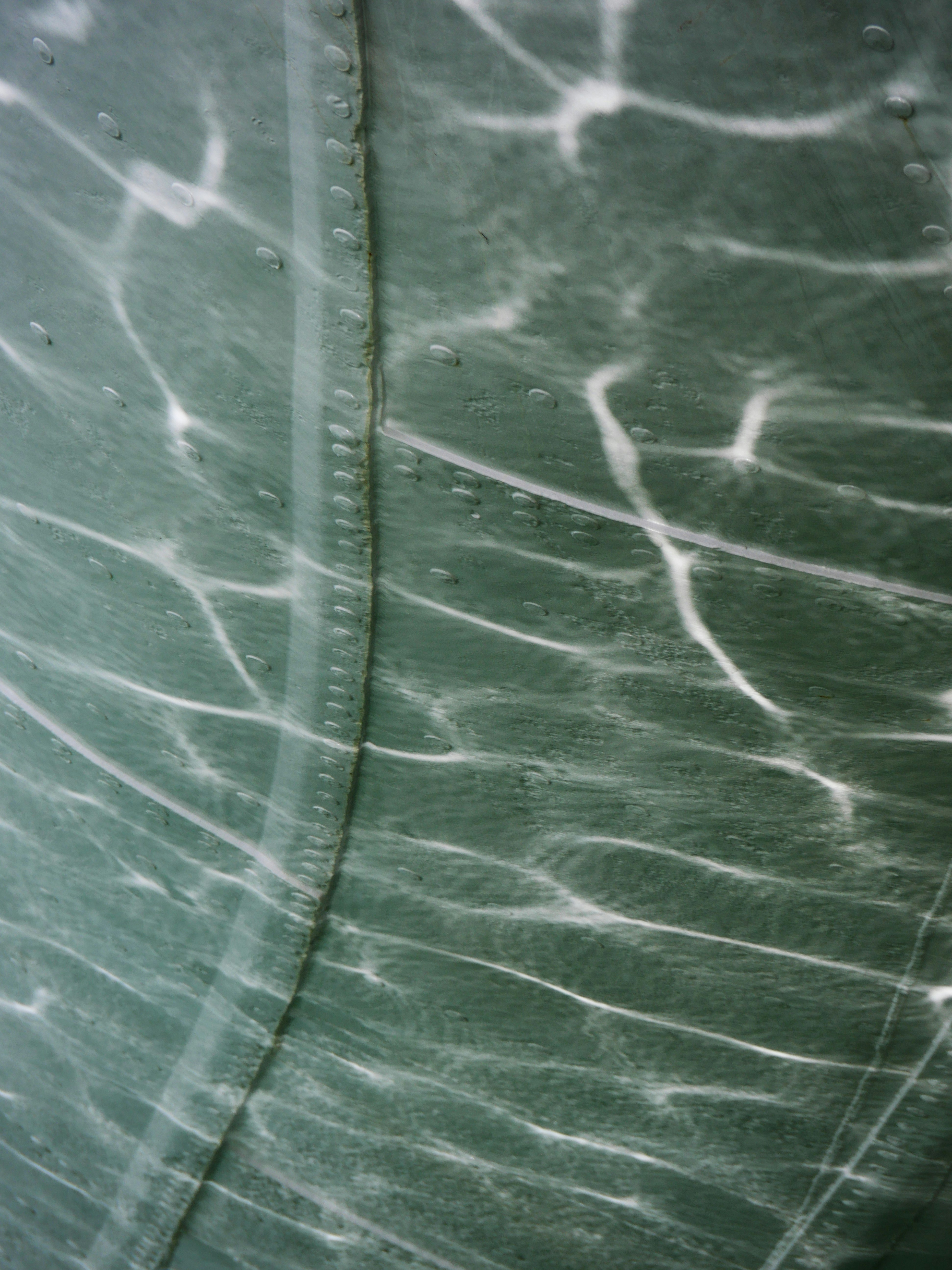 Abstract light patterns on a textured green surface. photo – Free ...