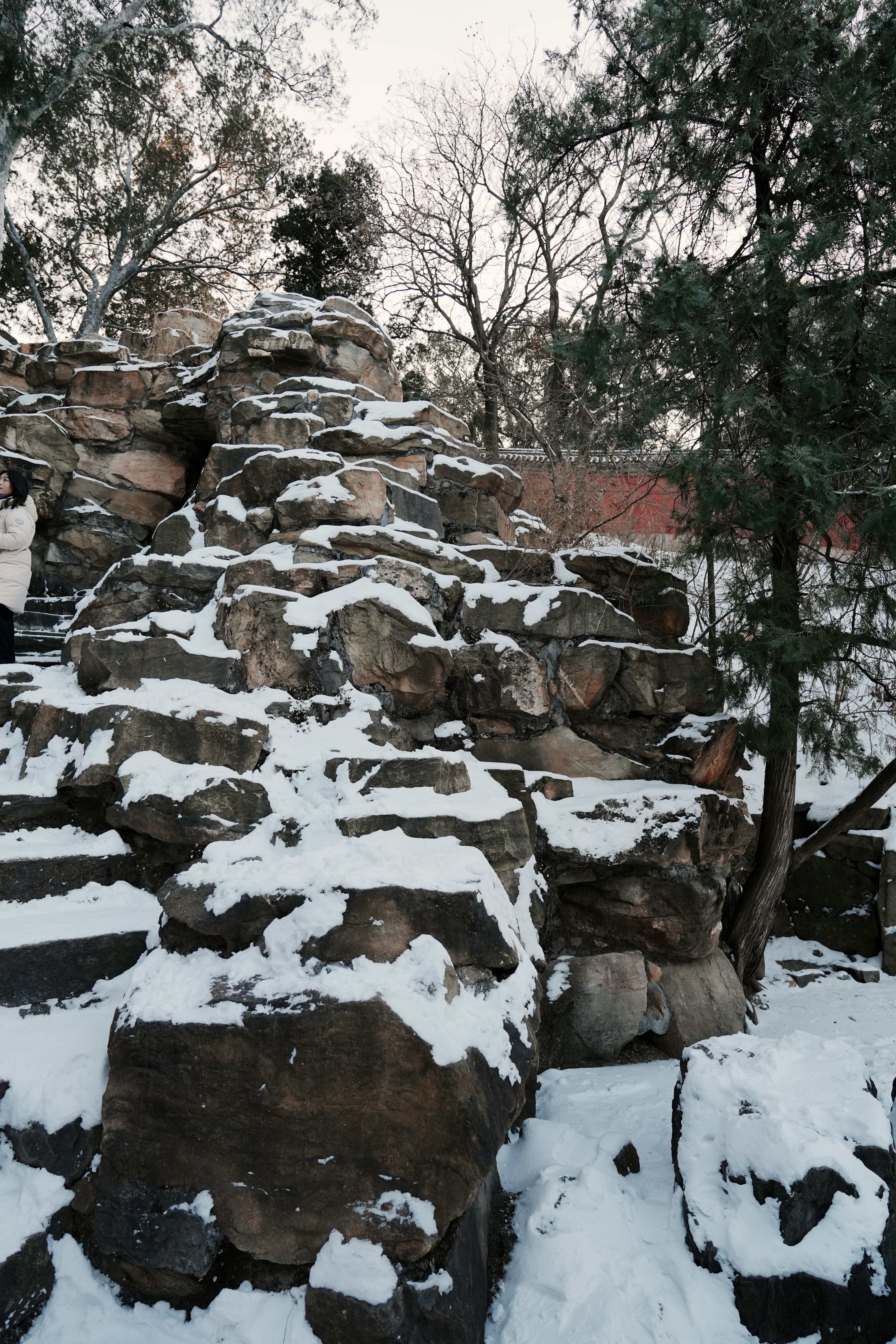 Snow-dusted stone stairway winding through a wintry landscape