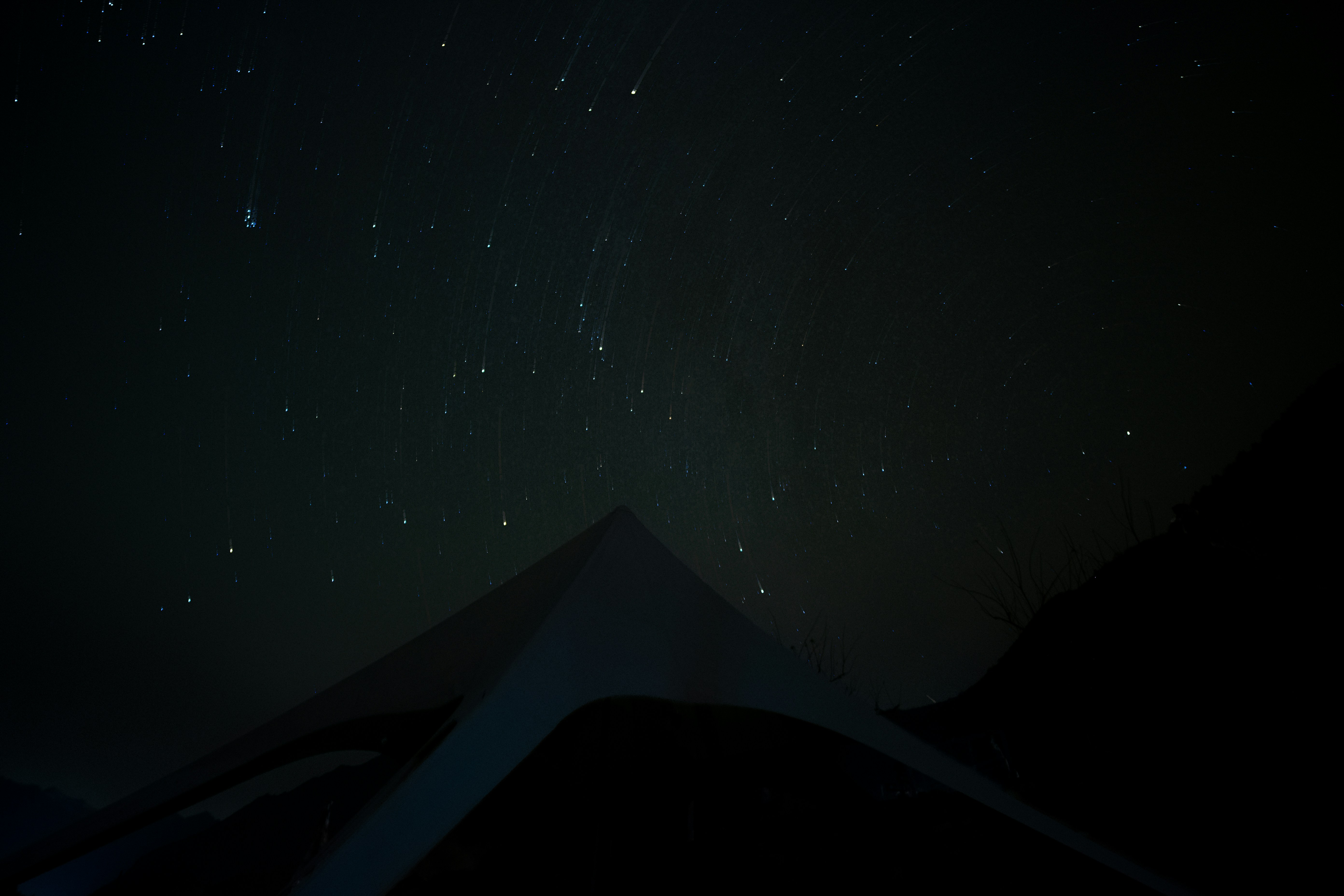 Starfall Over a Quiet Camp: A Night Sky Above the Tent Peaks