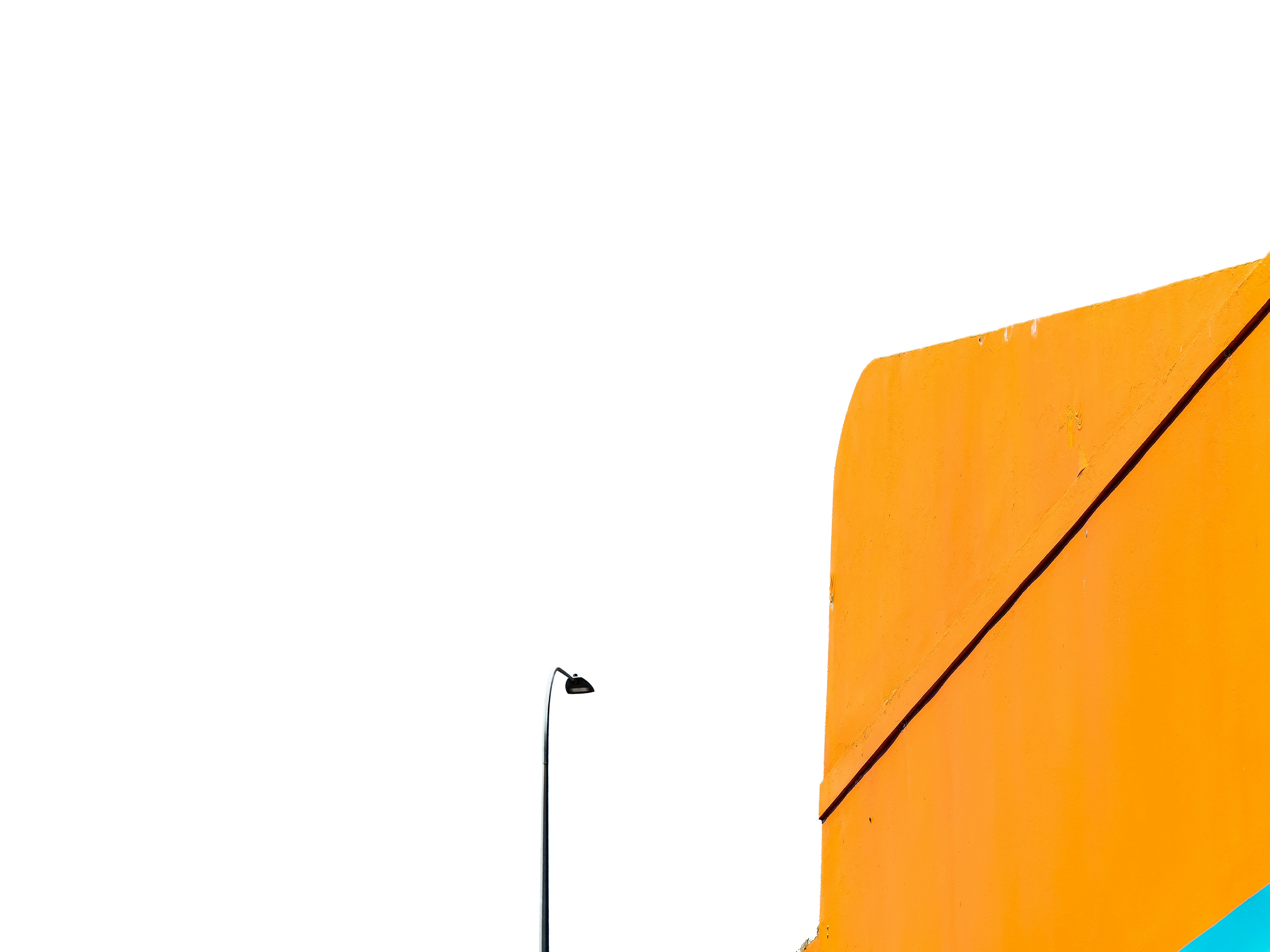 a street light next to a building with an orange facade
