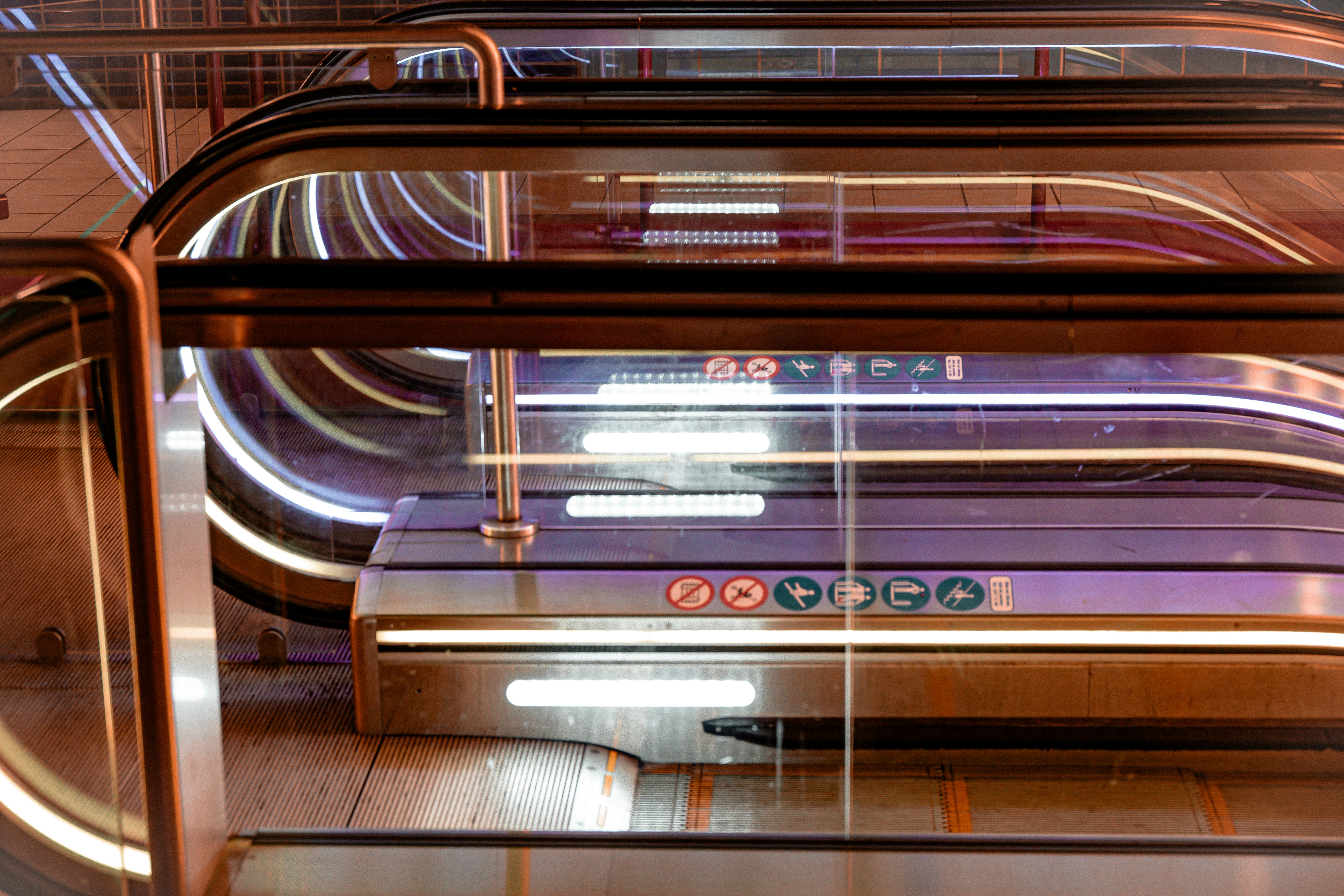 Neon Corridor: Reflections on an Escalator