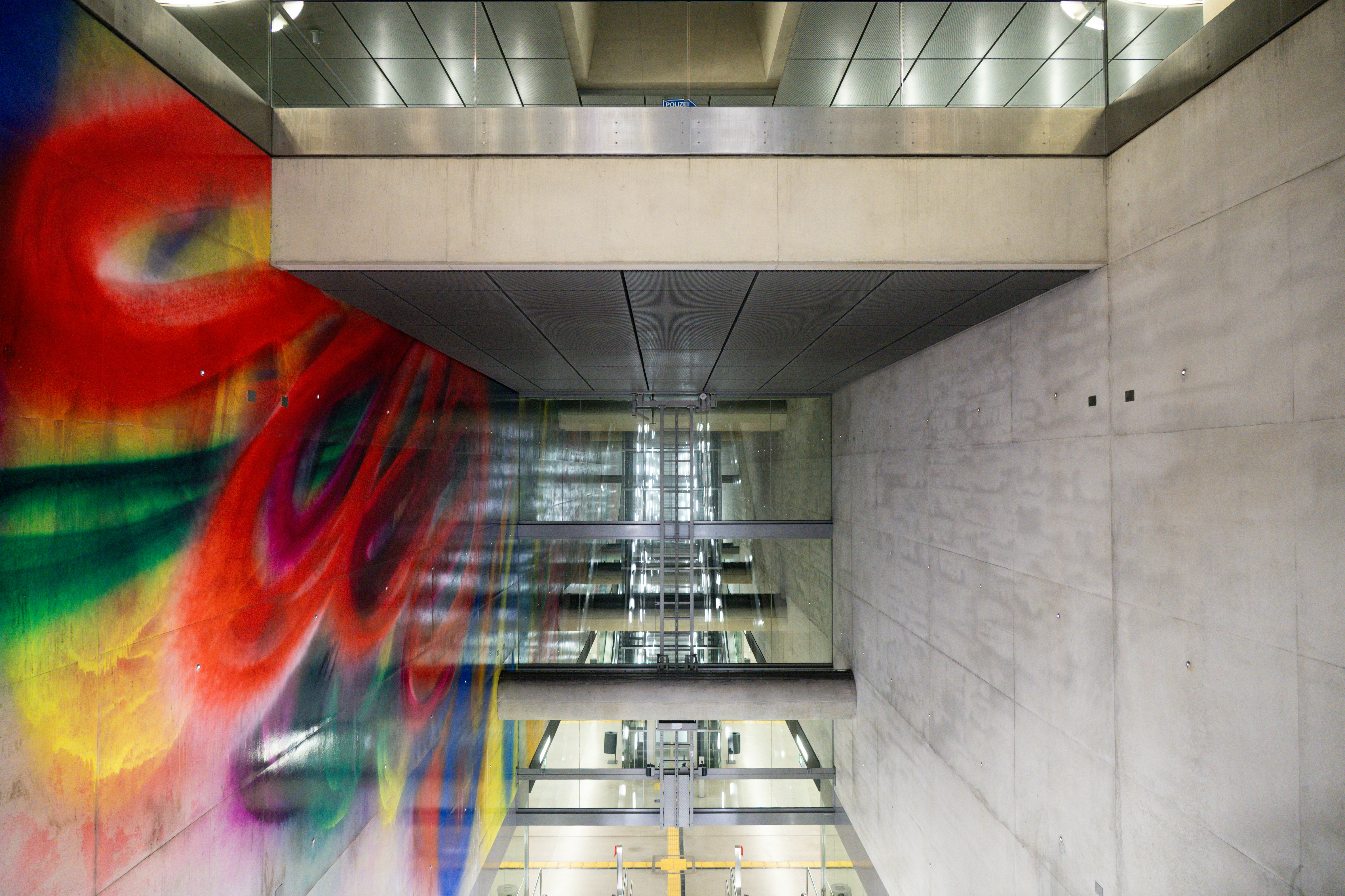 Urban Atrium in Motion: Diagonal Corridor Meets Colorful Wall