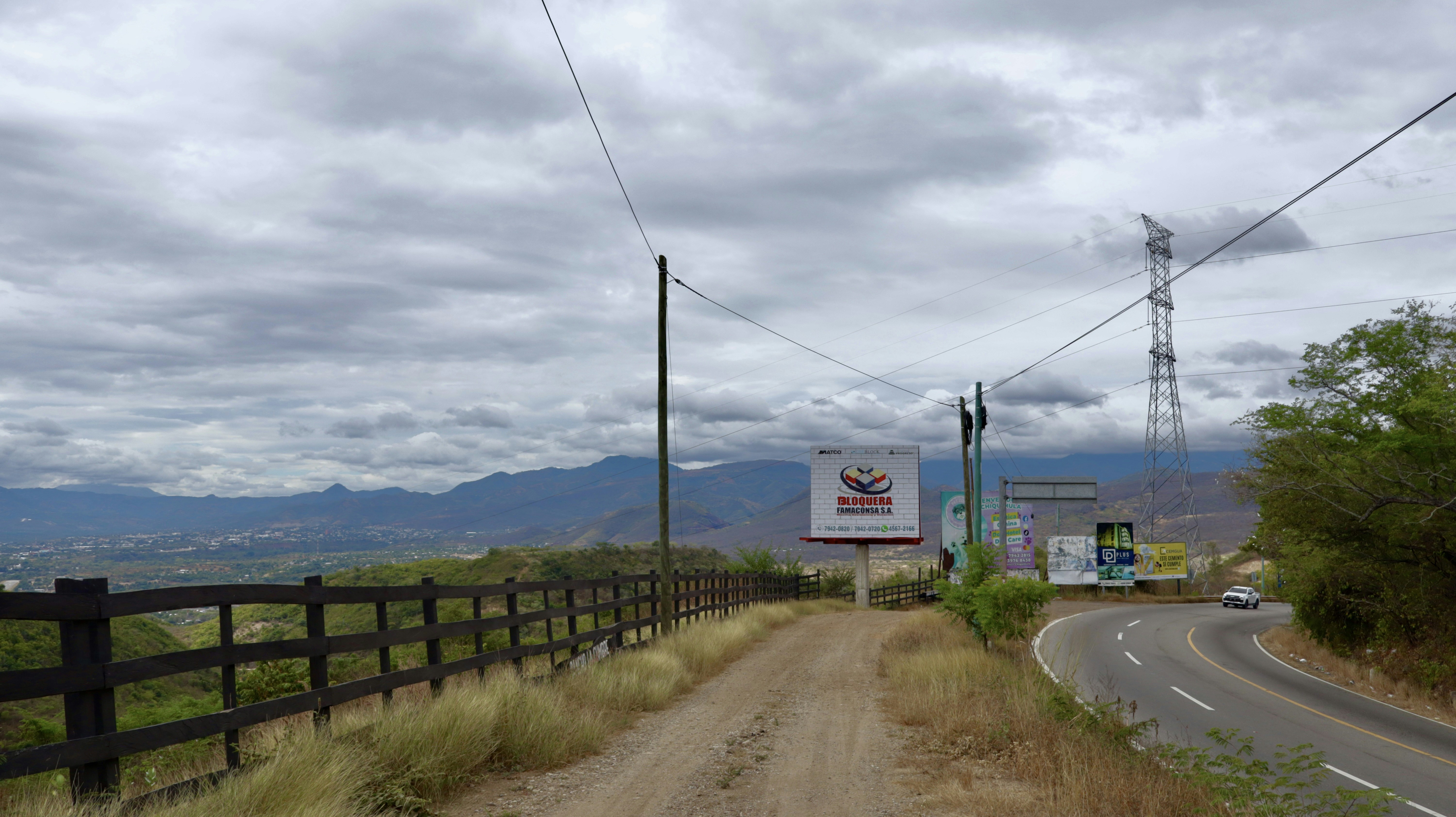 Roadside Vista into the Valley with Fenced Path and Signage