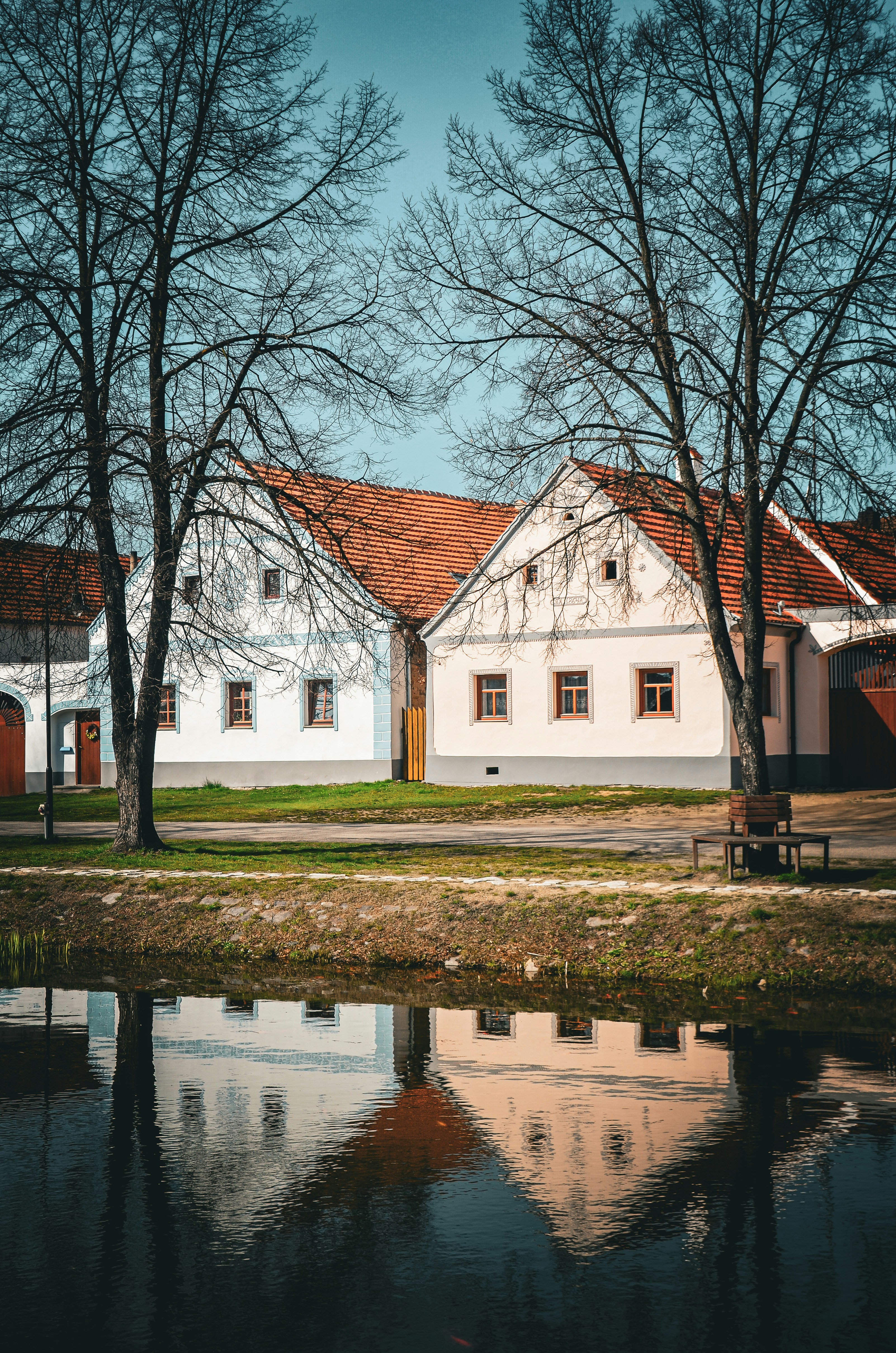 Echoes on the Canal: White Houses Reflected in Calm Water
