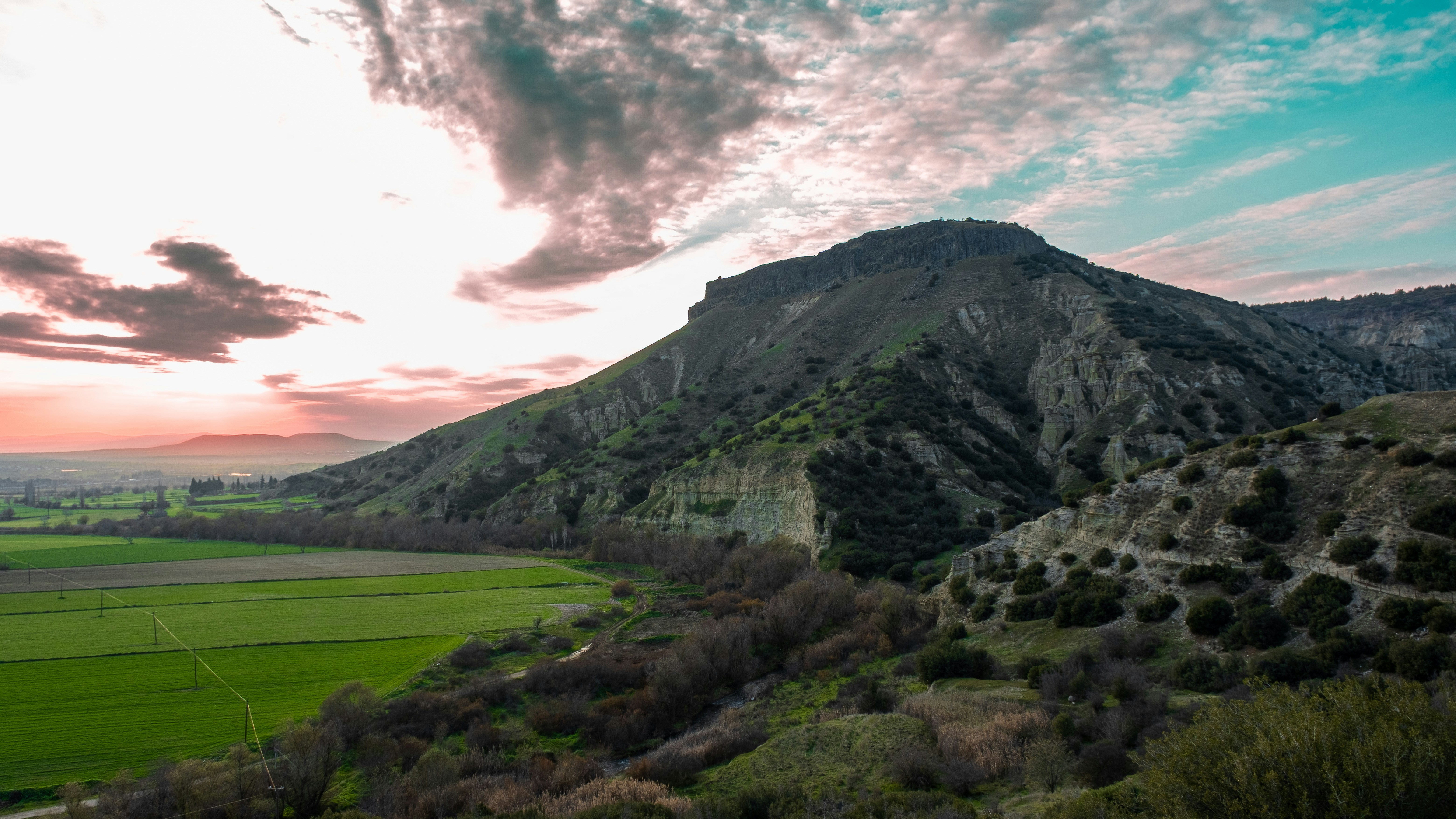 Sunset Over the Green Valley and Rugged Hill