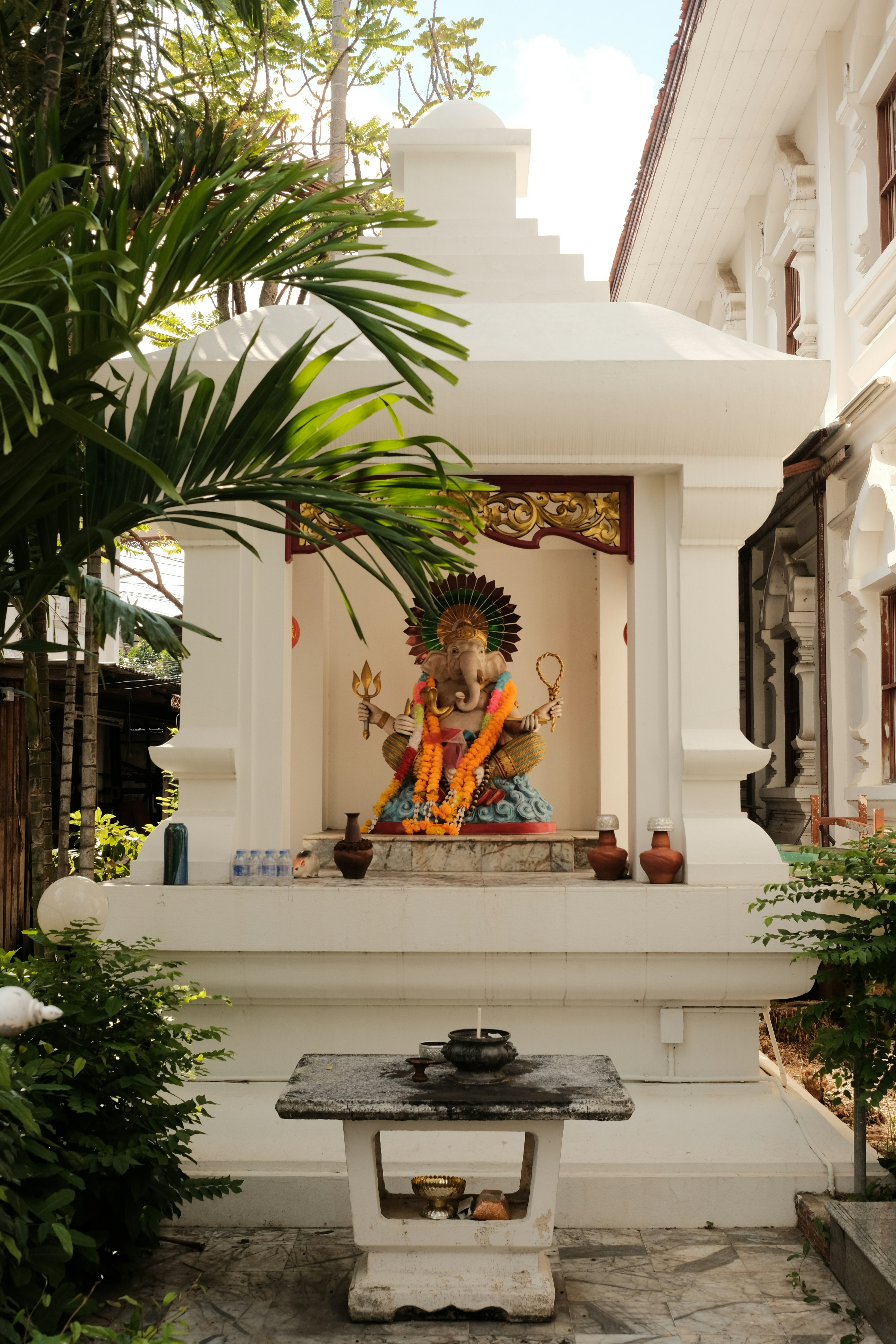 Sacred Shrine Framed by Tropical Foliage