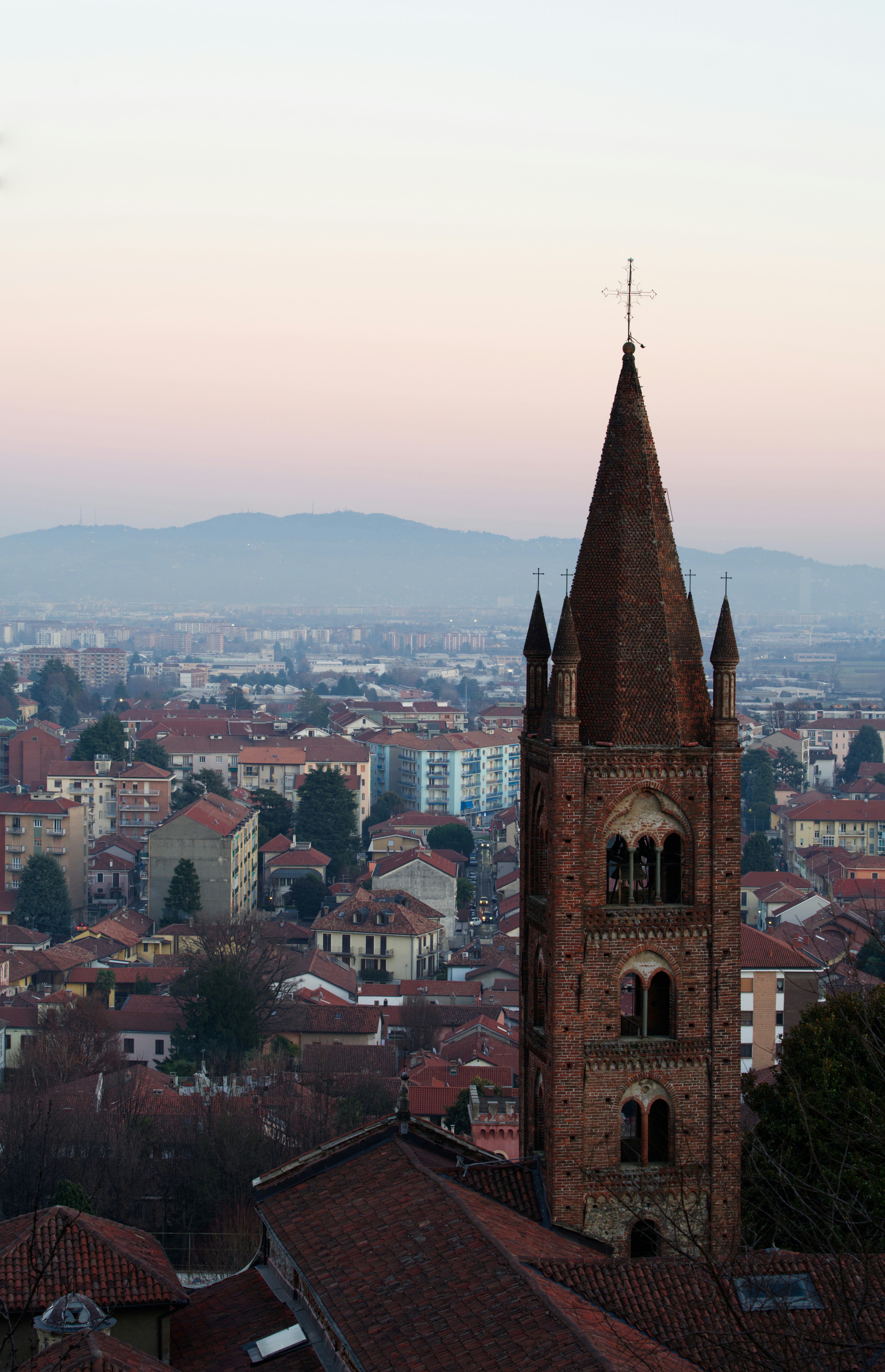 Towers of Red Clay Rise Above a Quiet Balkan Town at Dusk