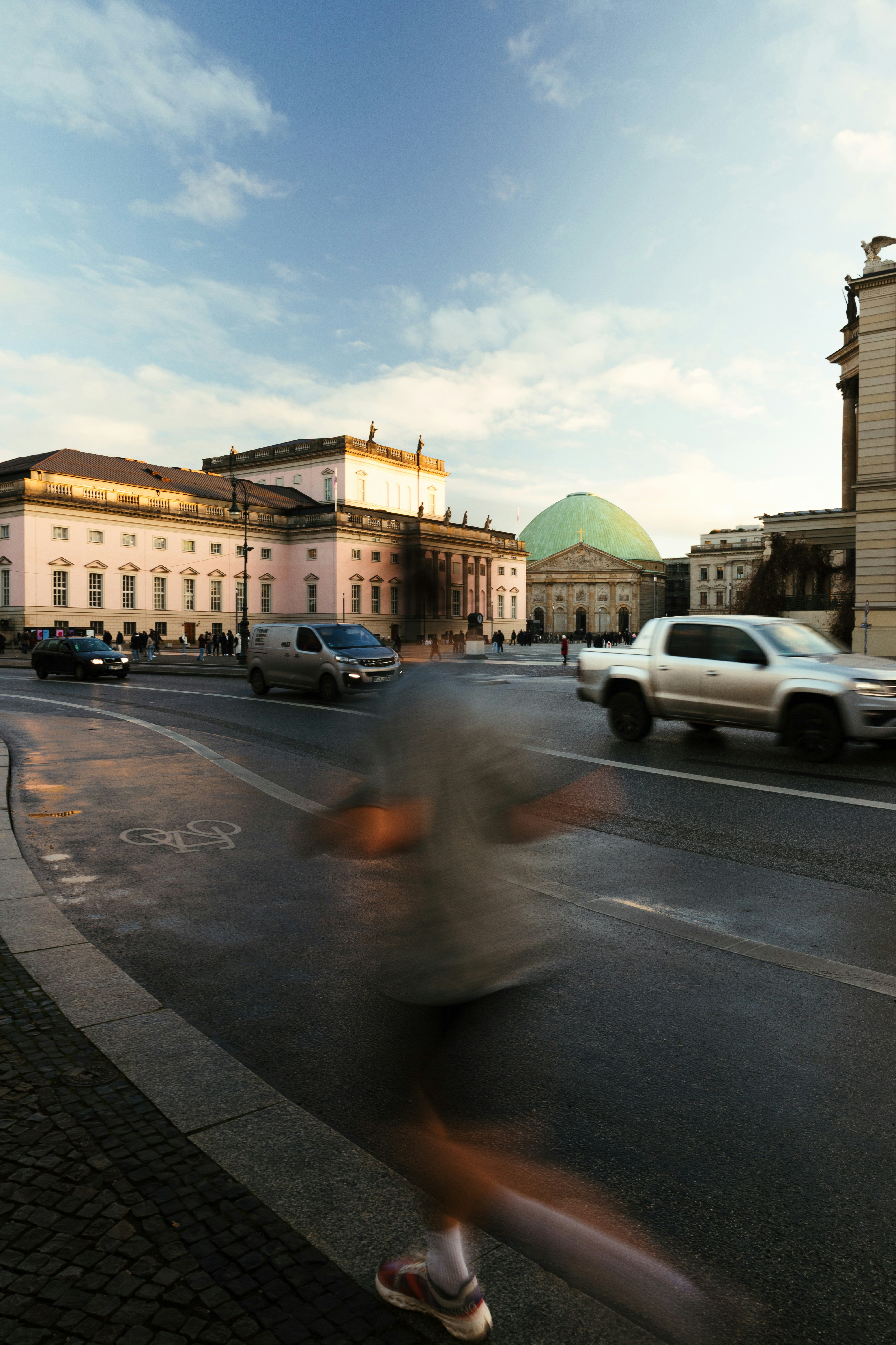 Bustling Piazza in Motion: A Cityscape with Moving Figures and Historic Domes