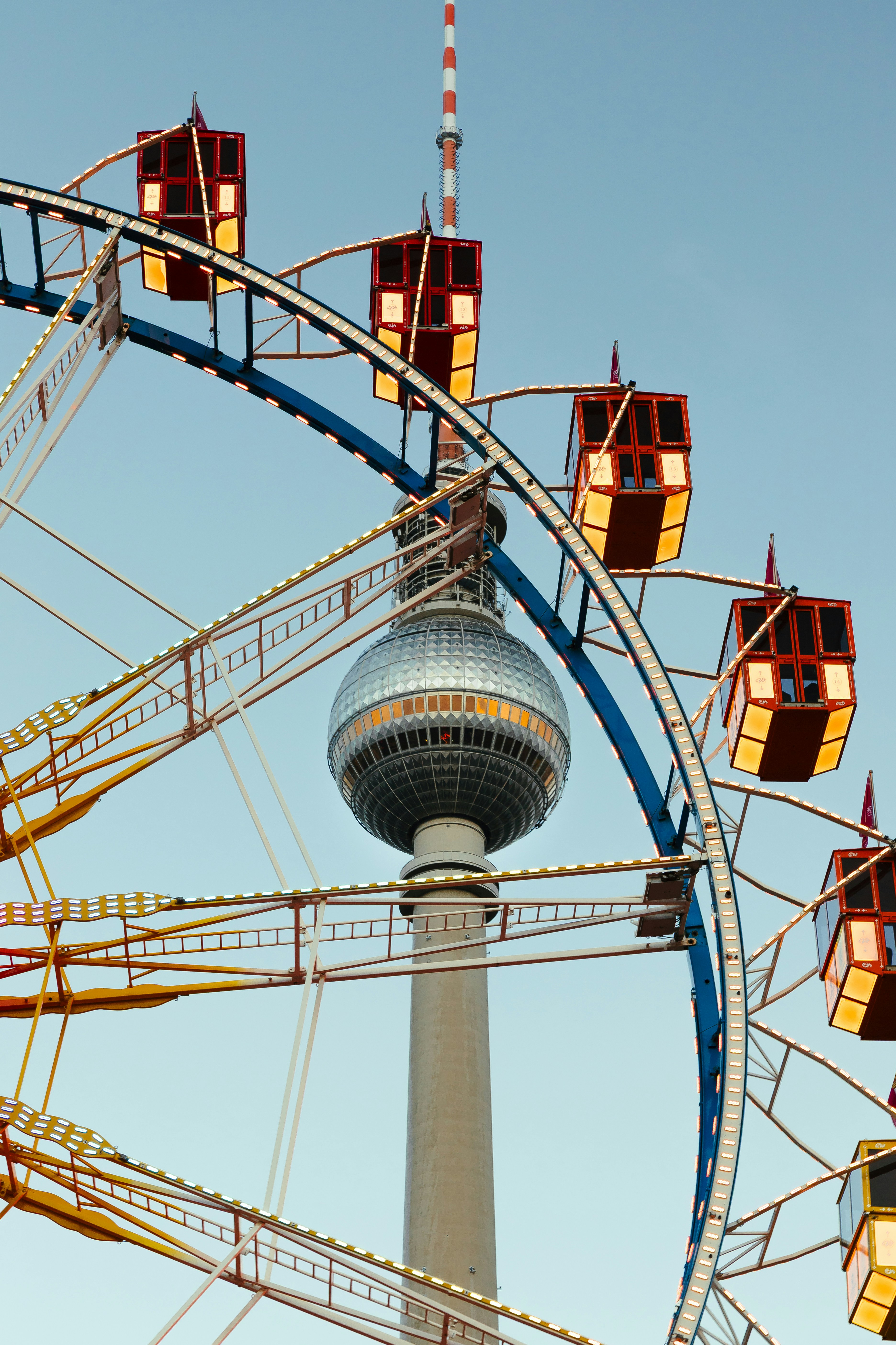 Skyward Gears: The Berlin Fernsehturm Framed by a Ferris Wheel