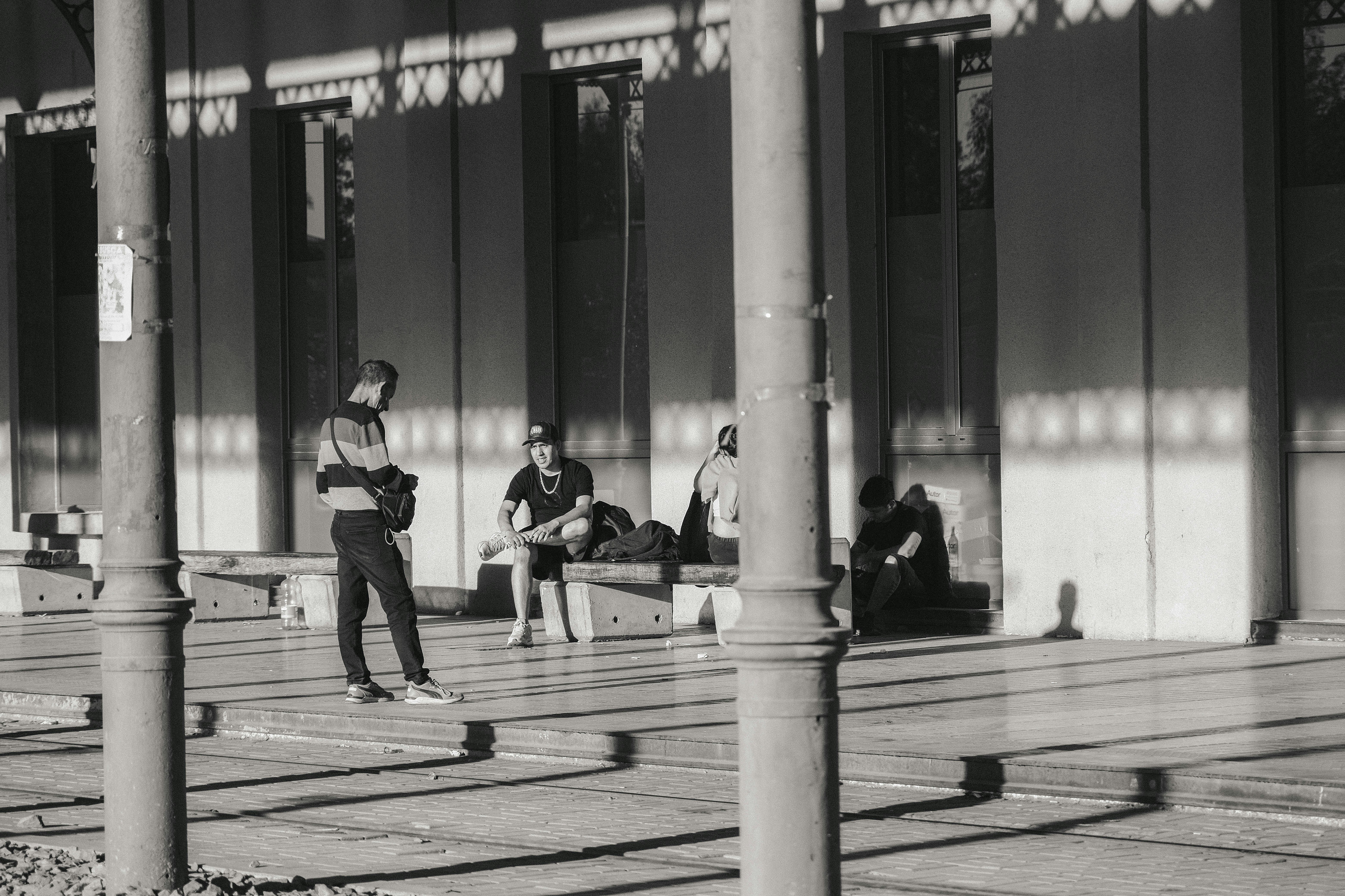 Waiting in the Shade: A Quiet Moment Under Architecture