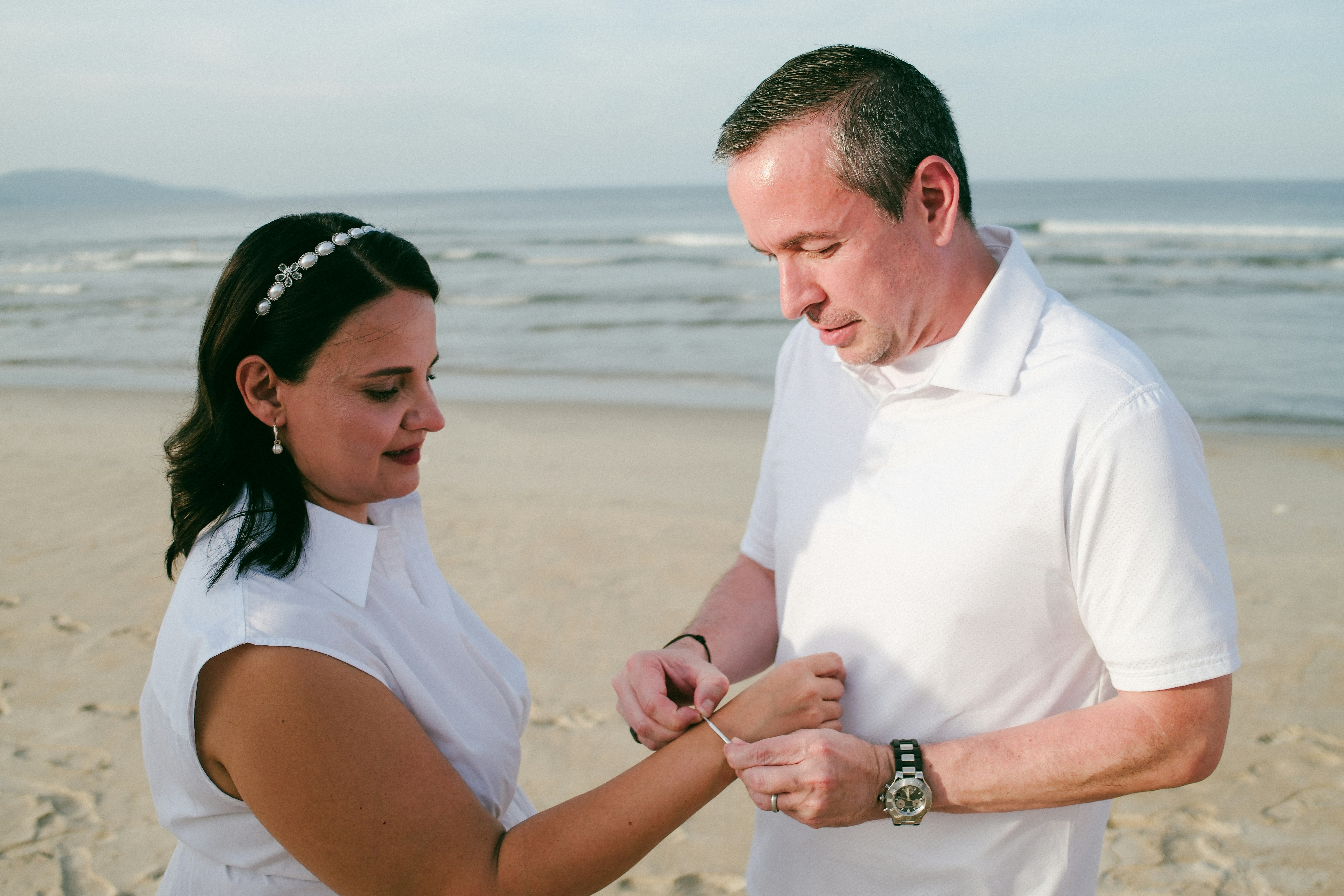Beach Moment: A Couple Seals a Memory with a Shared Wrist Gesture