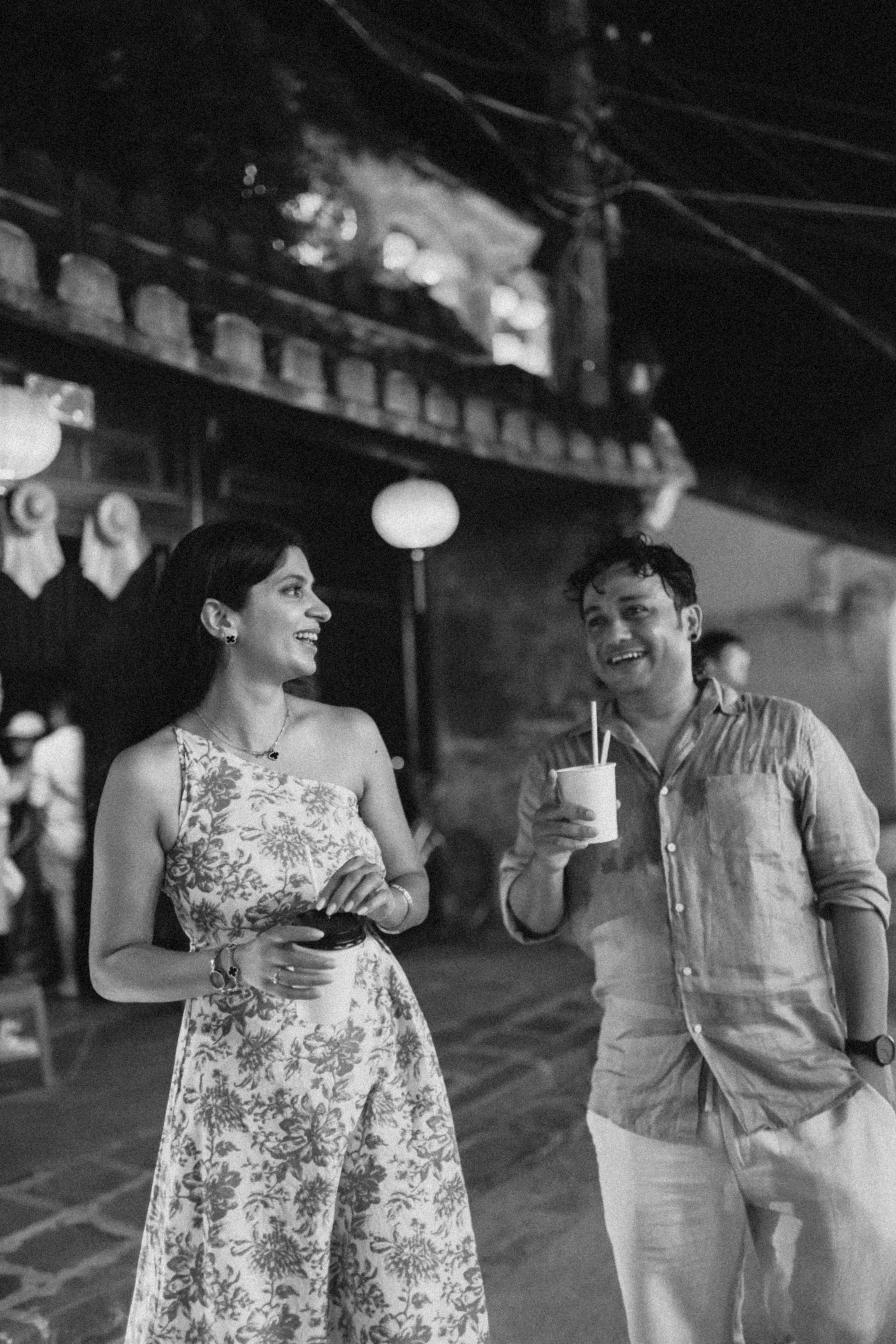 Night stroll smiles: a candid duo in monochrome charm