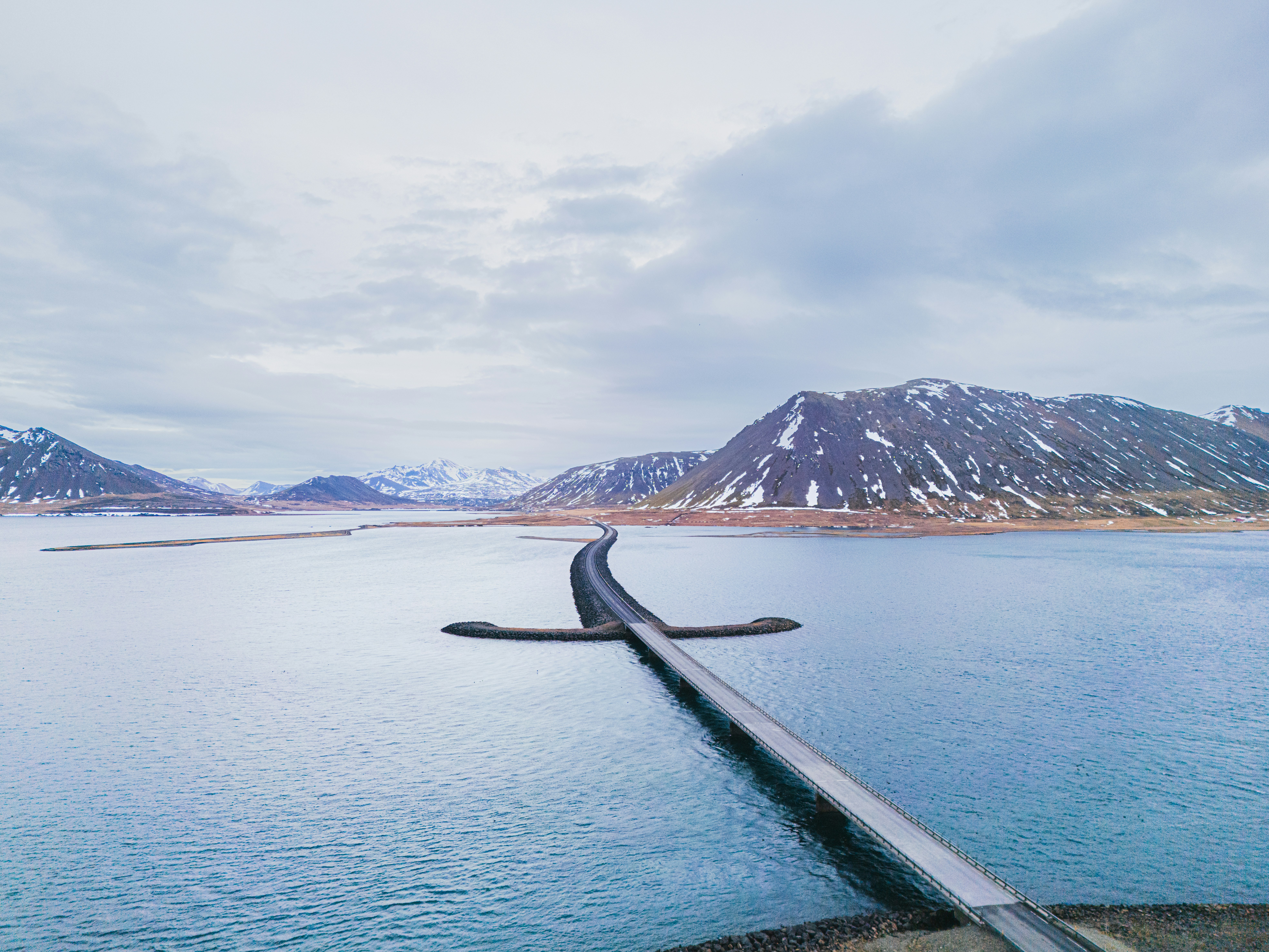Curved Causeway Over A Glacier Blue Sea