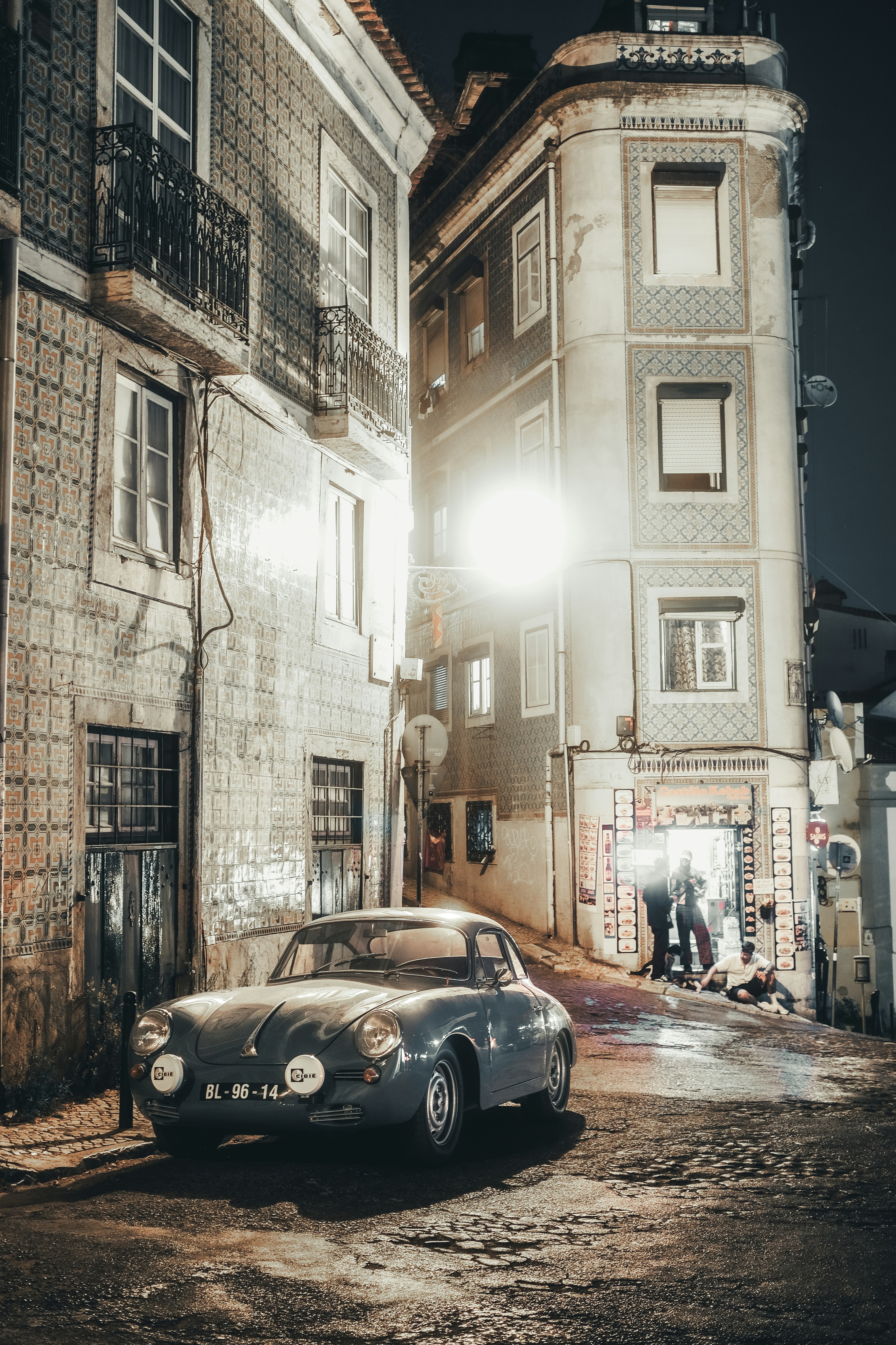 Classic Coupe in a Rain-Washed Lane under Neon Glow
