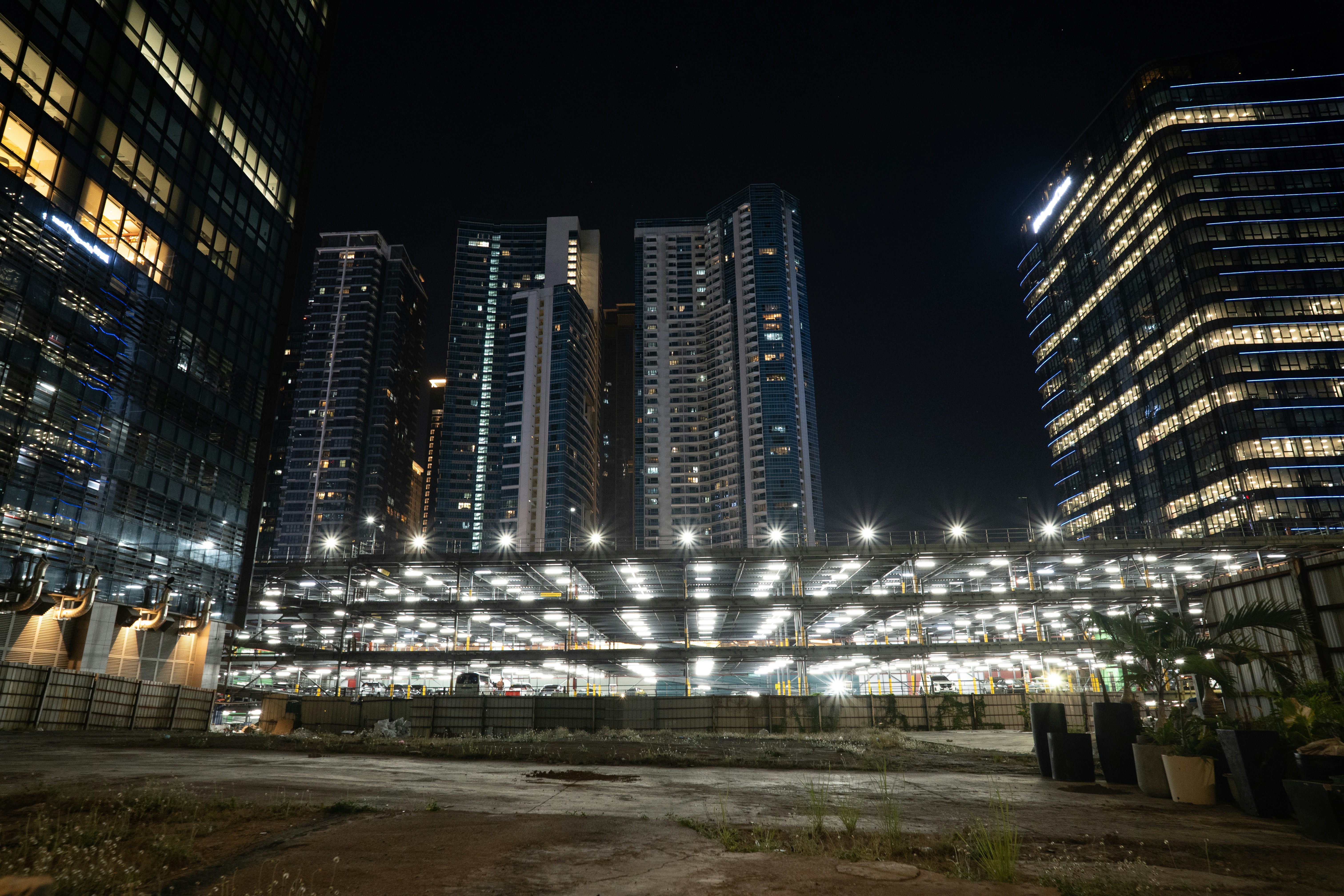 Night Structural Palette: Bright Terraced Carpark Surrounded by Skyscraper Canopy