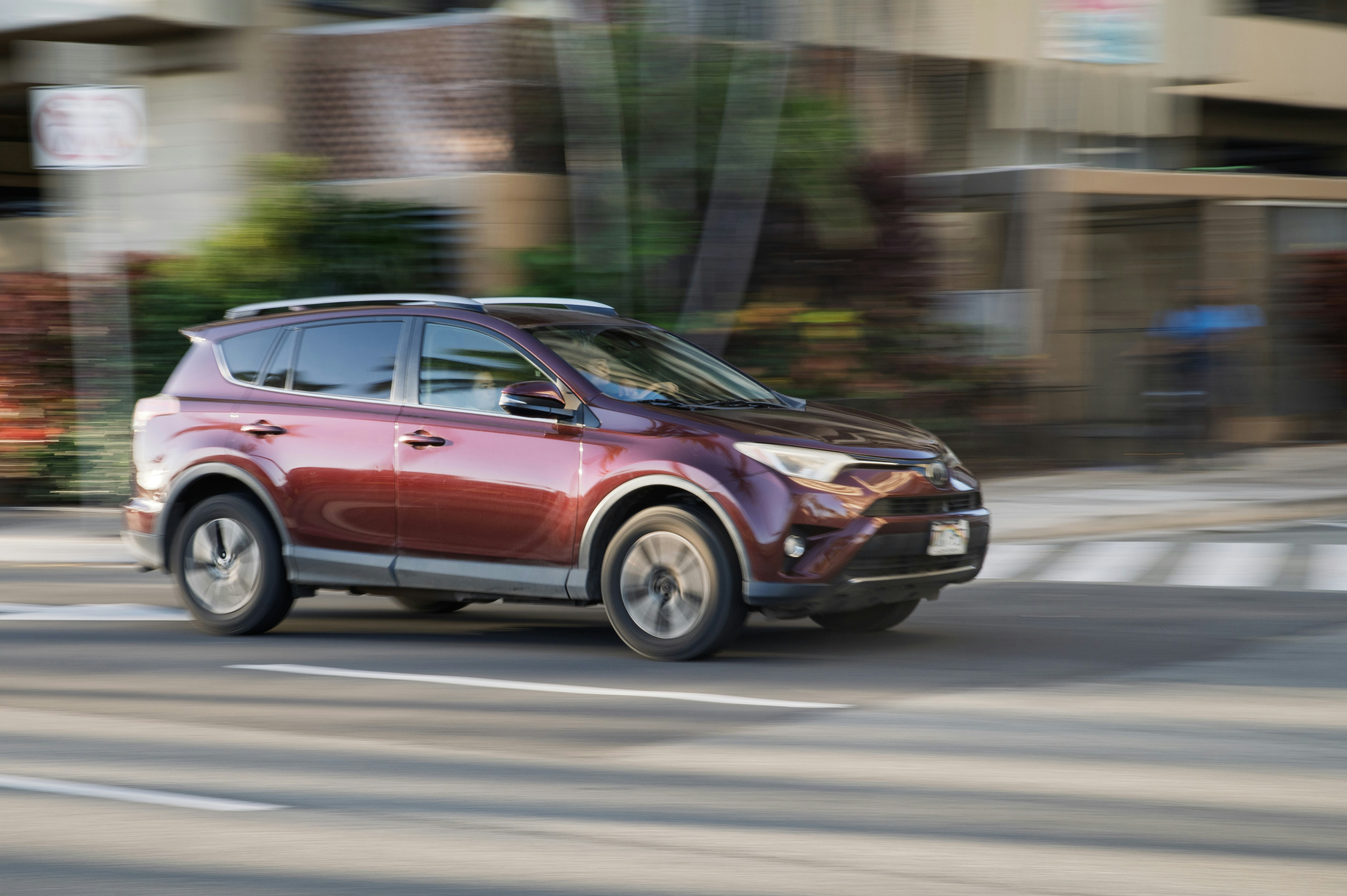 Motion Blur on a Burgundy SUV: Street Spotlight in Motion