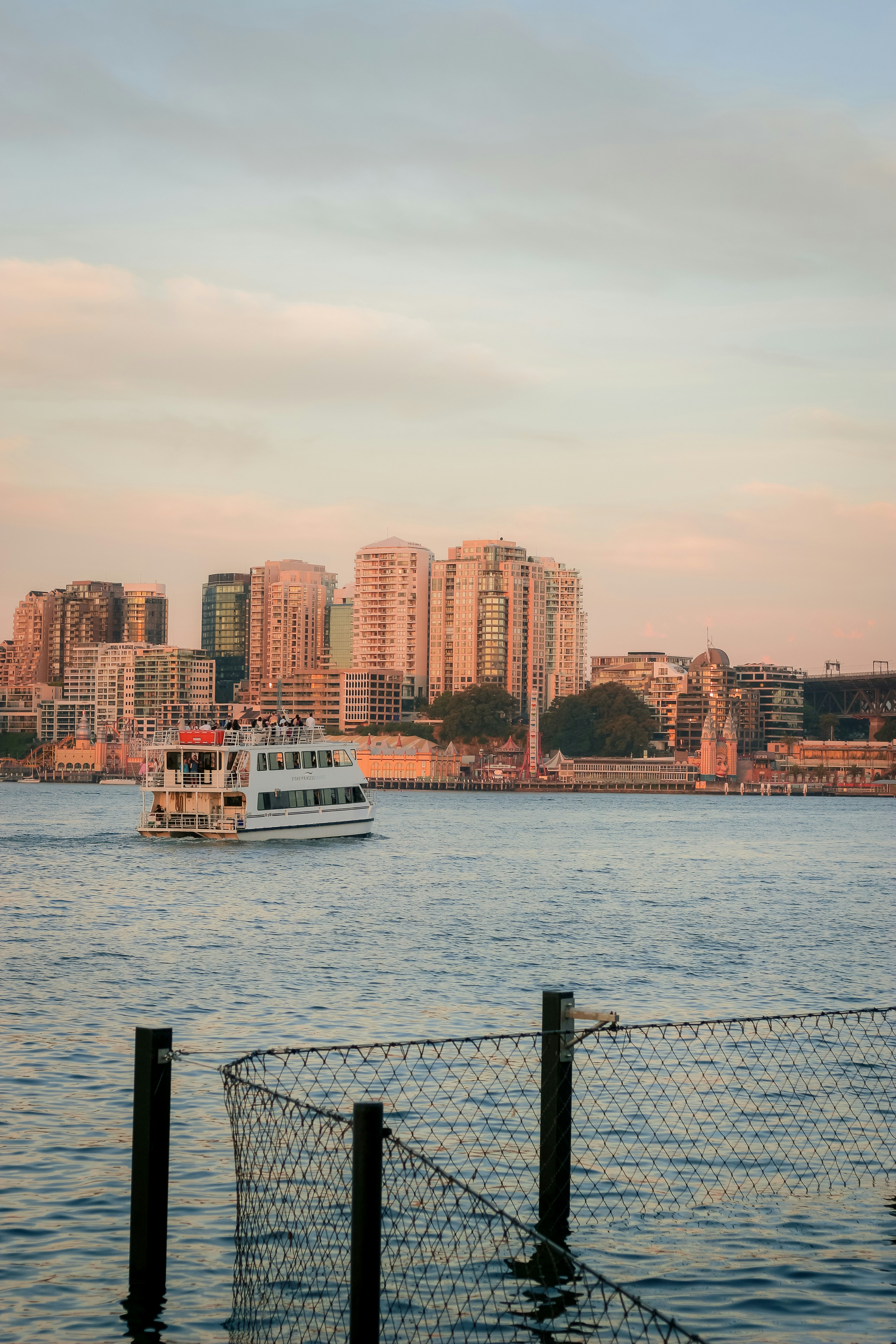 City Horizon Drift: A Sunset Ferry Over Quiet Waters