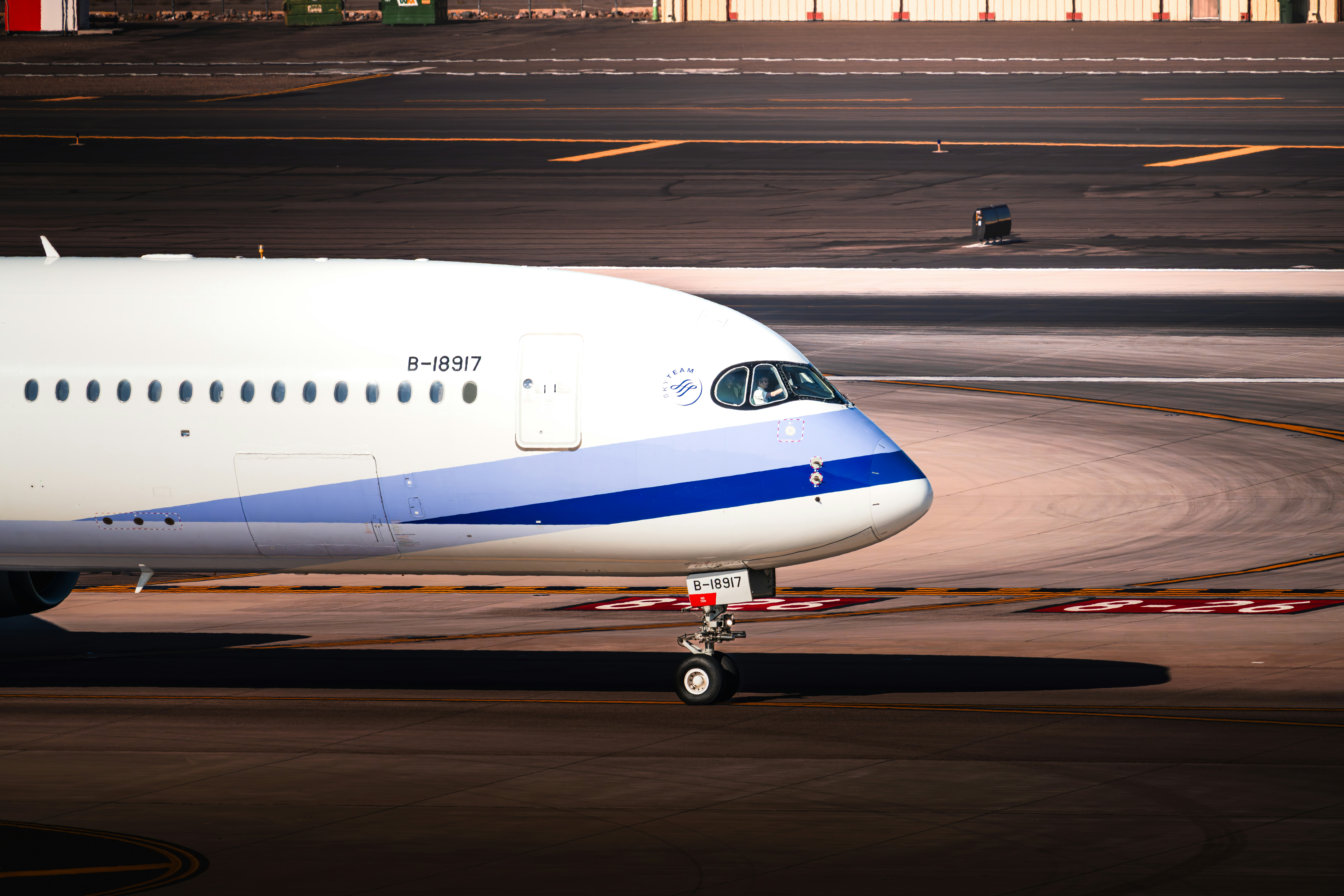A white airplane with blue stripes on the runway photo – Free Travel ...