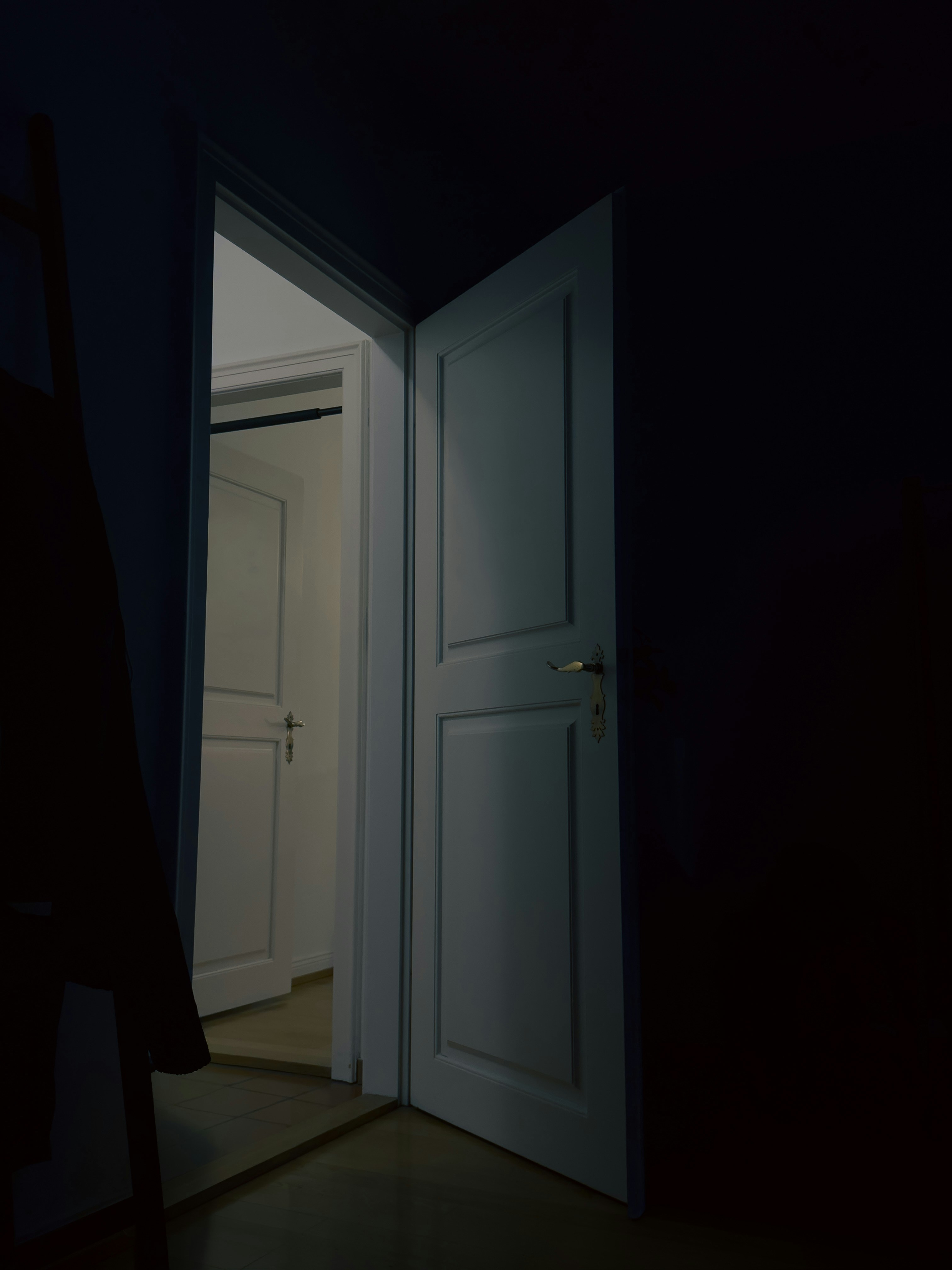 Doorway to a Quiet Corridor: A Dimly Lit Split Between Rooms