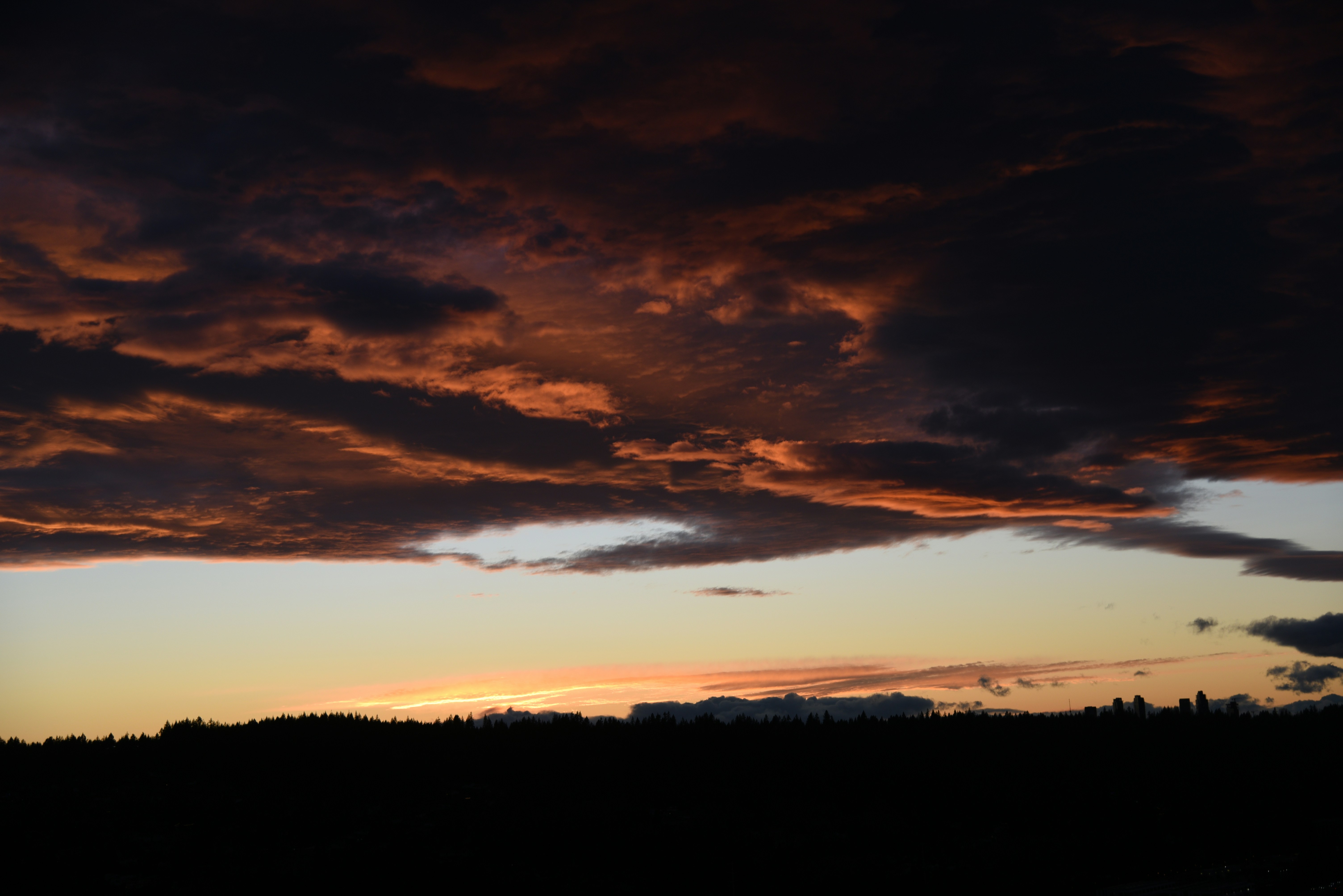 Lowland Horizon Ablaze: A Quiet Dusk Against a Darkening Sky