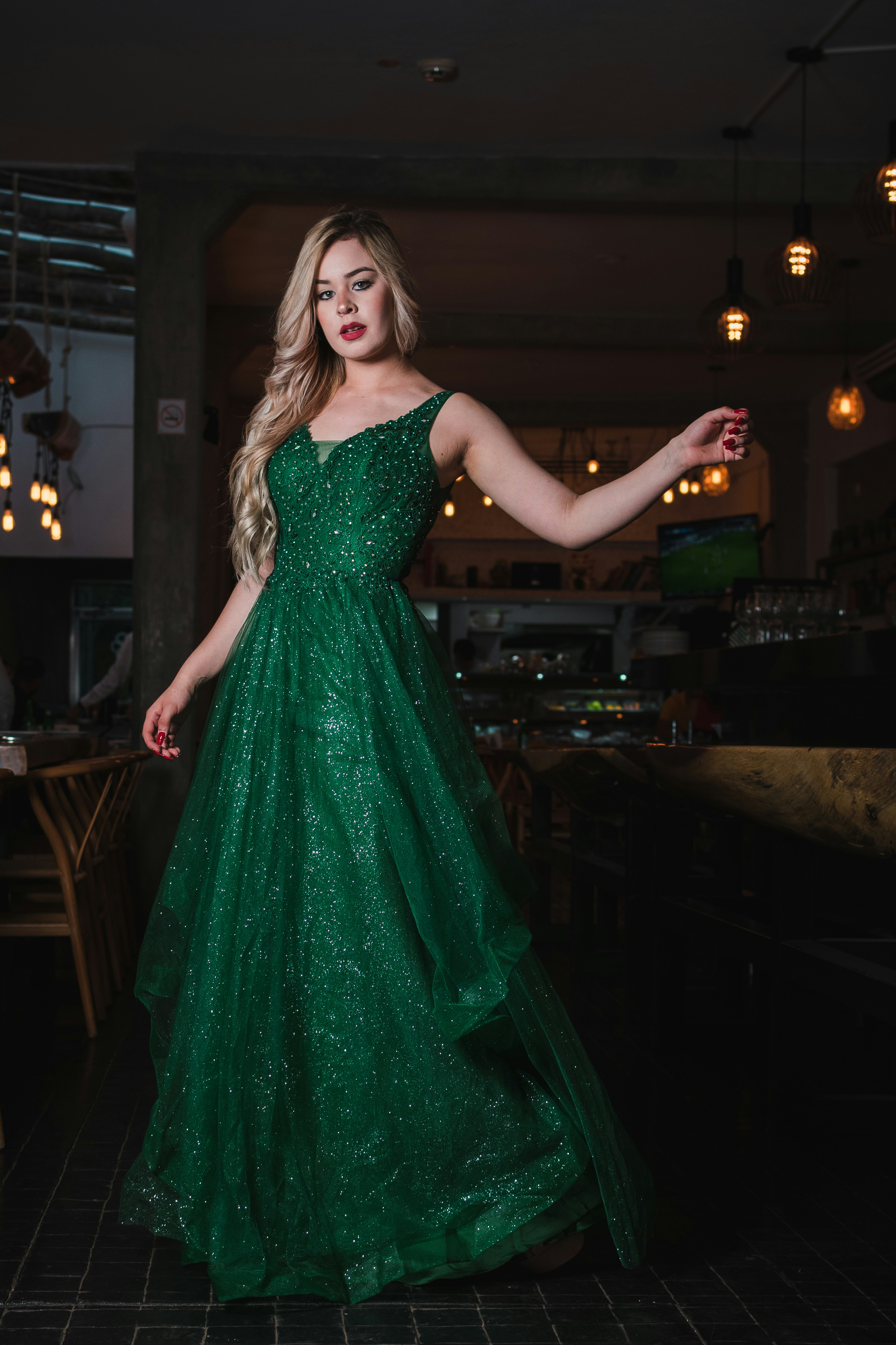Emerald Gown in a Dim Bistro
