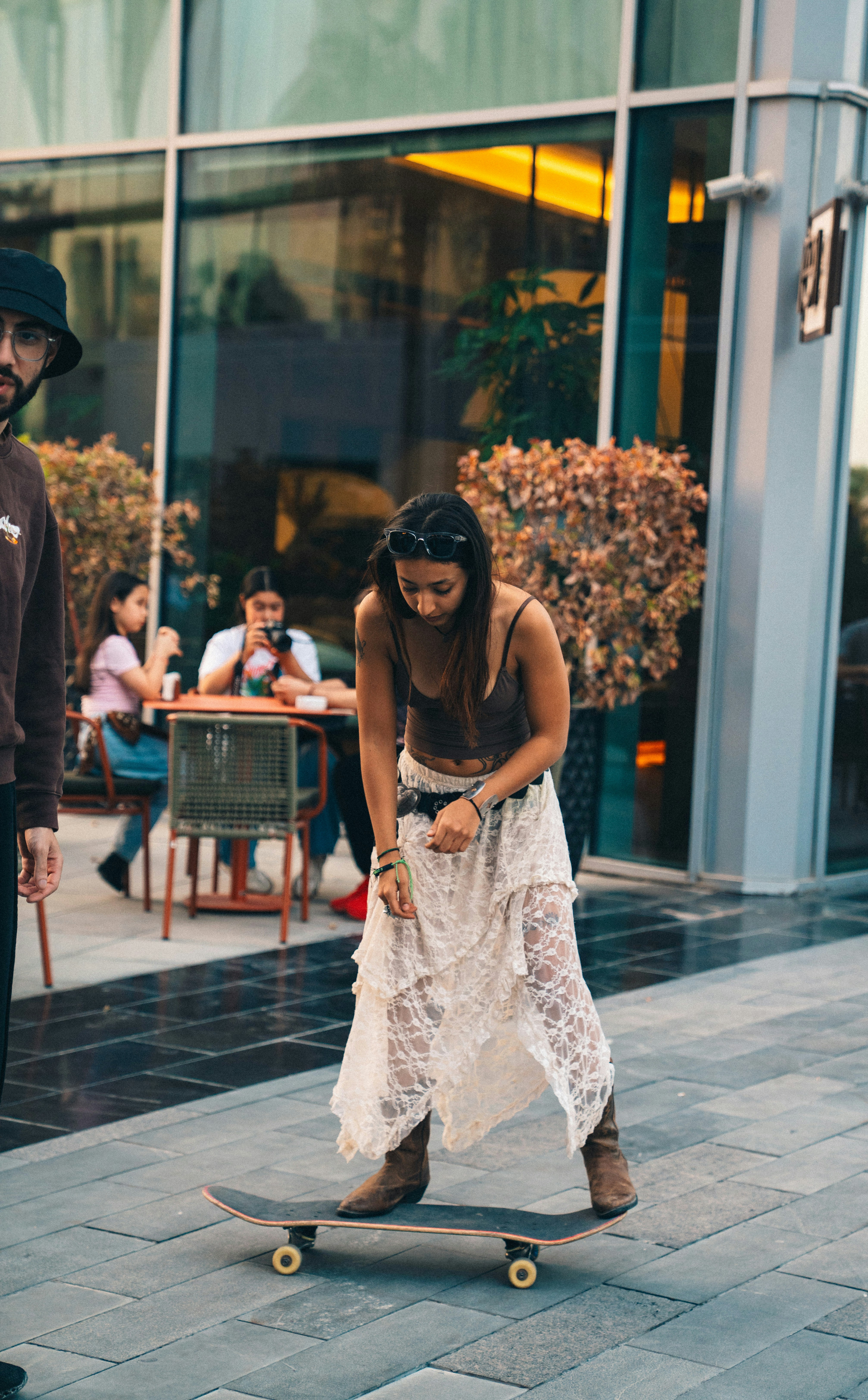 Skateboarder in motion: lace-skirted style meets urban rhythm